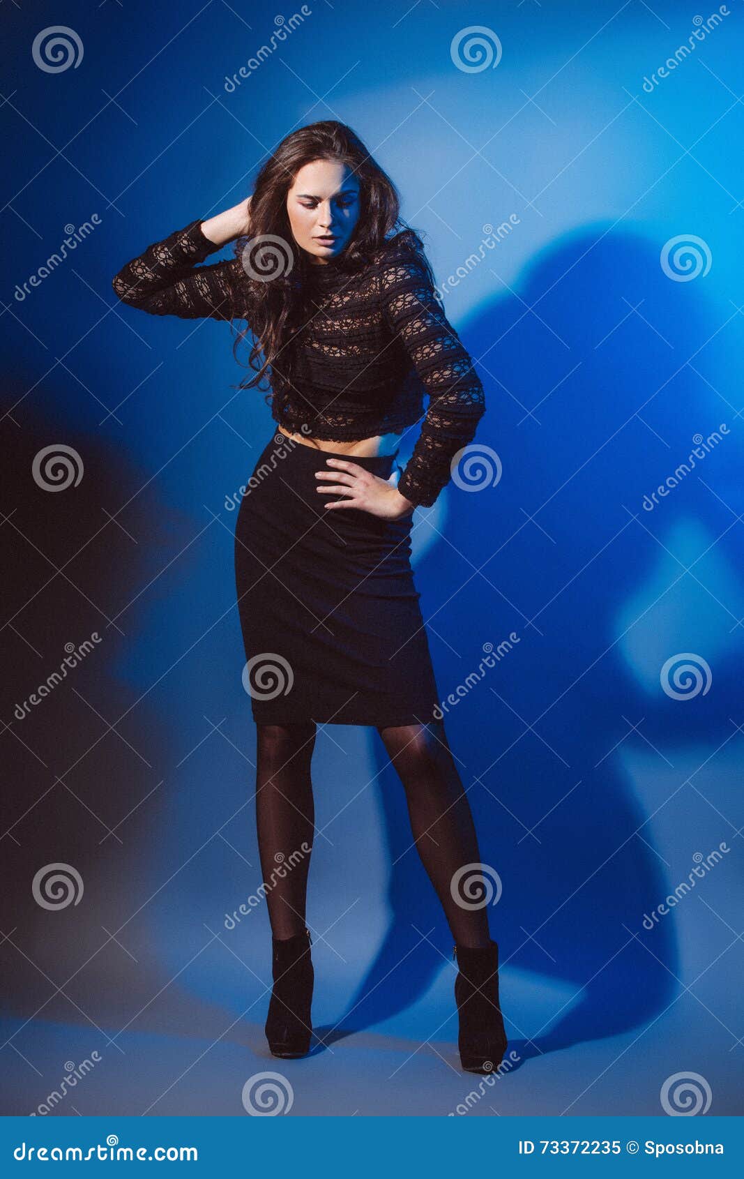 Slender Fashion Model in Black Clothes on a Blue Background. Stock ...