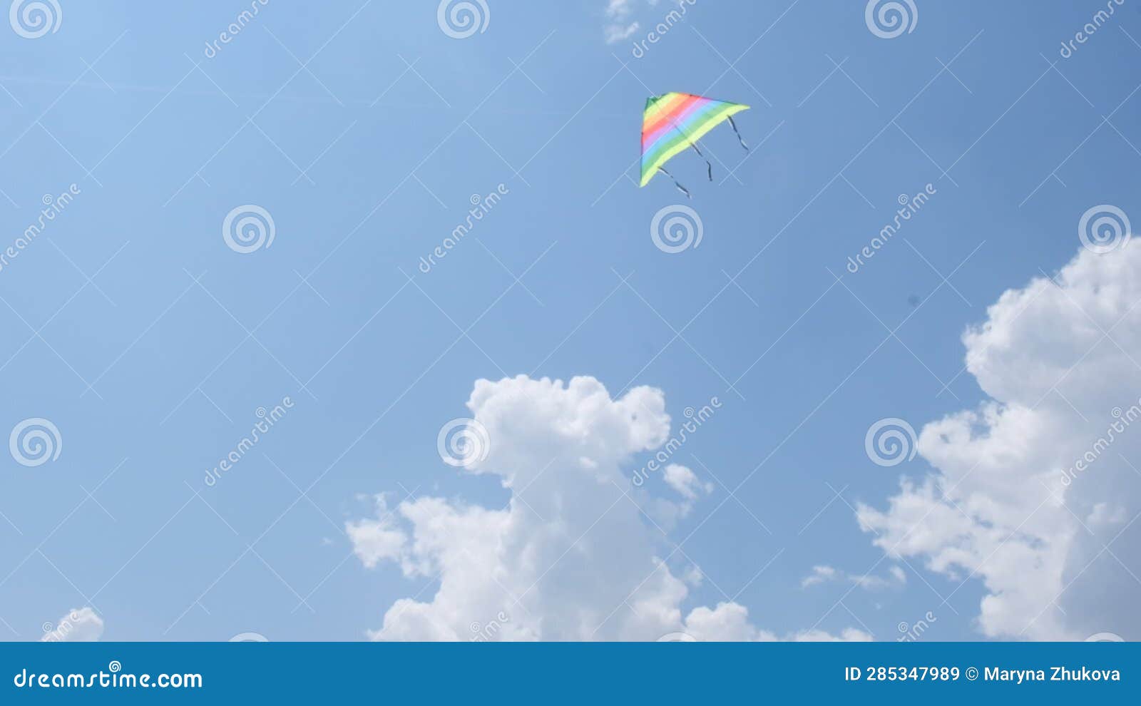 A Slender Man on the Beach is Flying a Multi-colored Kite. Active ...