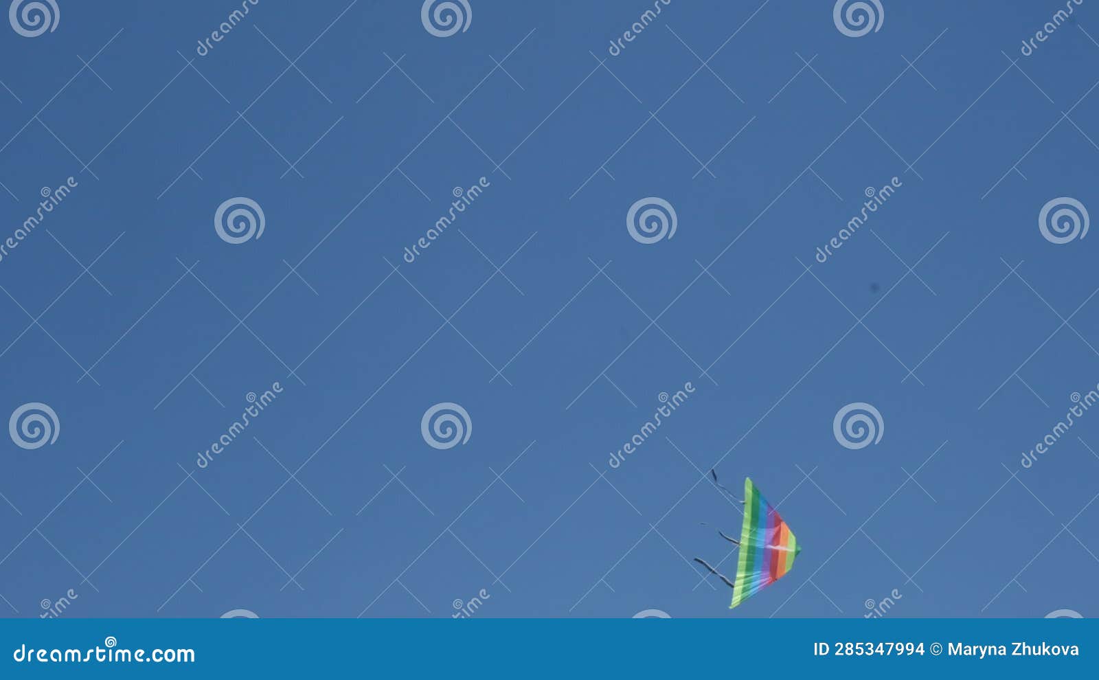 A Slender Man on the Beach is Flying a Multi-colored Kite. Active ...