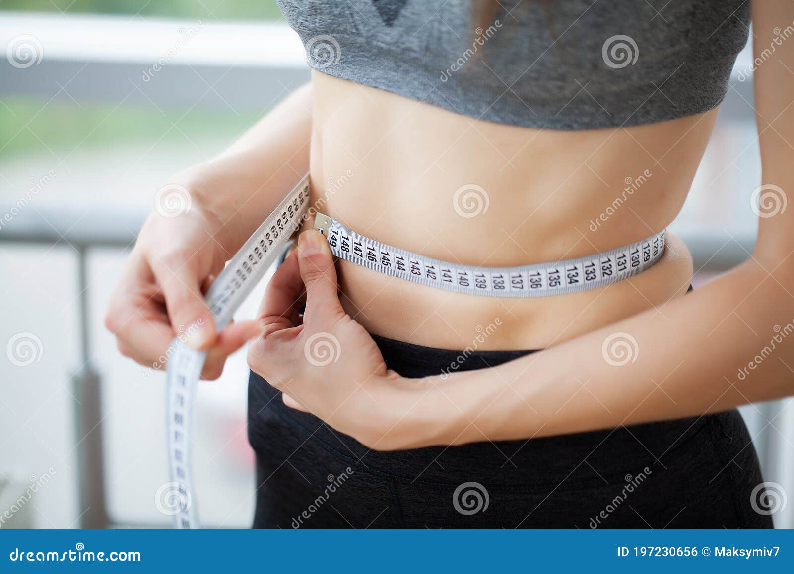 A Slender Woman Measures the Size of Her Waist. Stock Photo - Image of ...