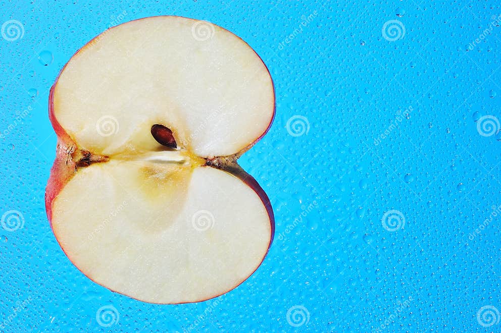 Apple with drop on blue stock photo. Image of drop, slice - 29747892