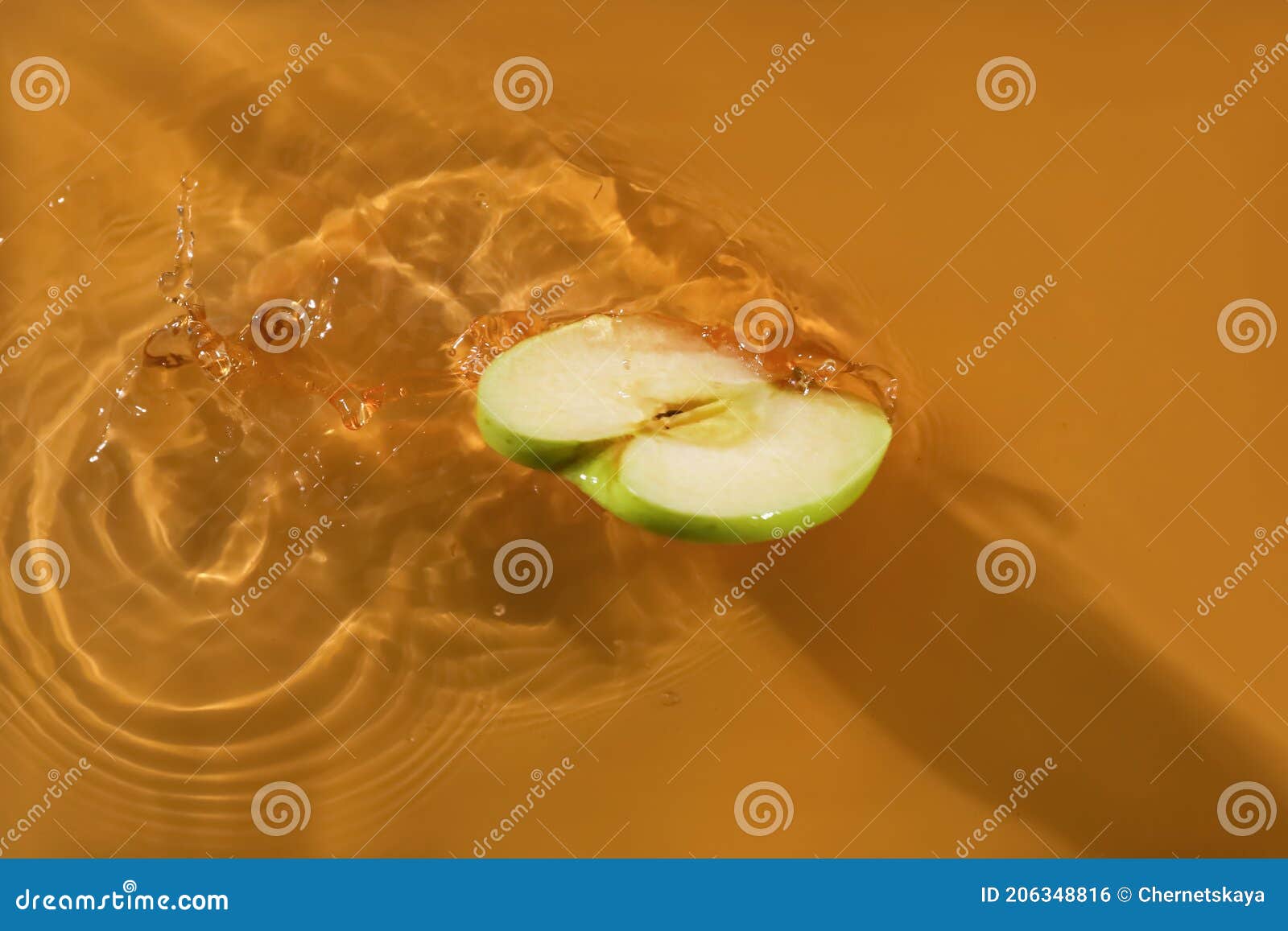 Slice of Apple Falling in Juice with Splash, Top View Stock Photo ...