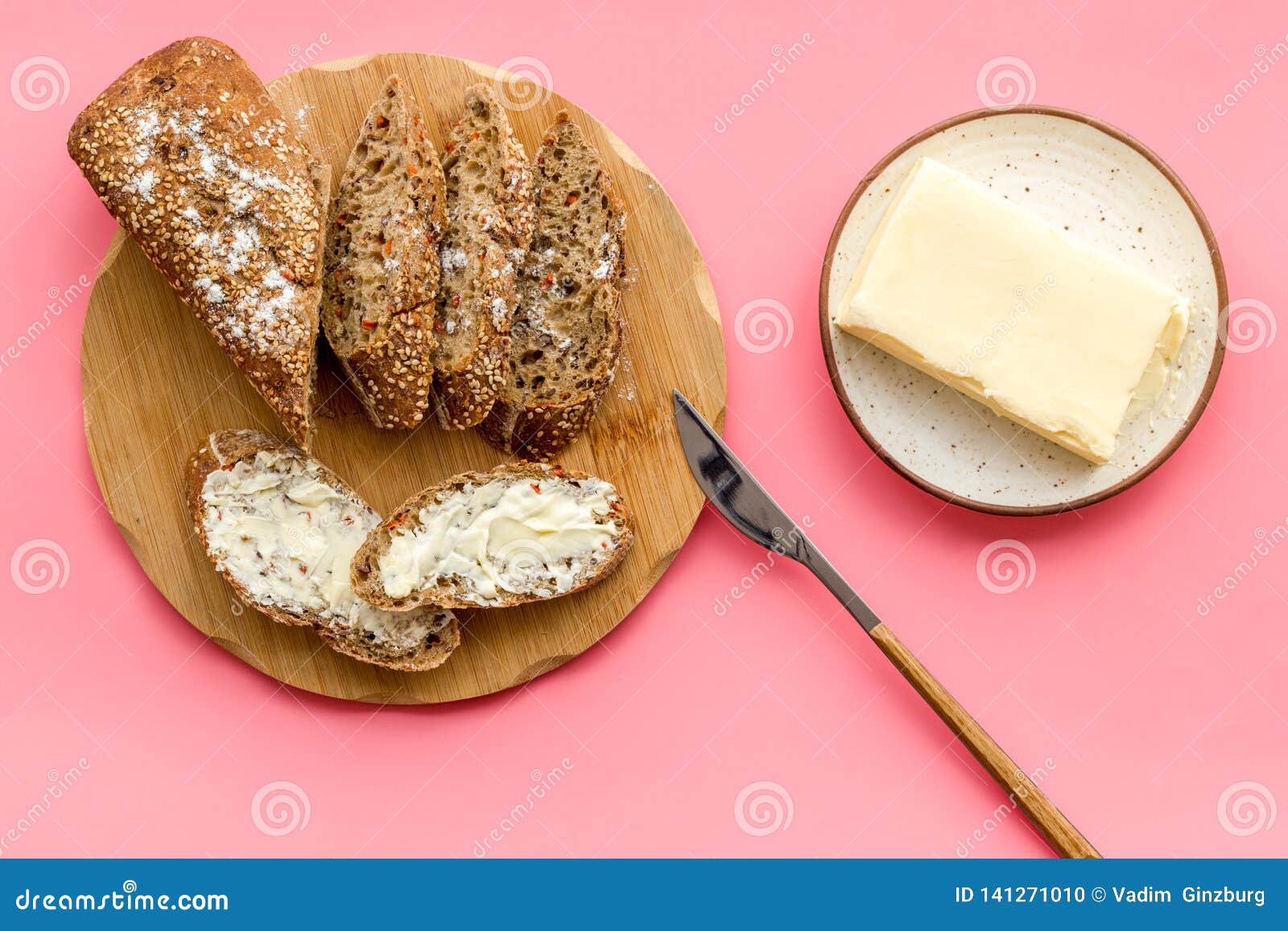 Slice of Bread with Butter on Pink Background Top View Stock Photo ...