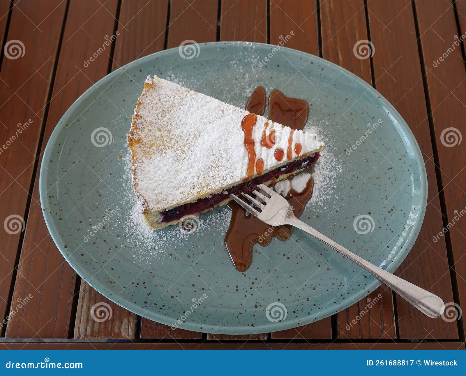 A Slice of Cherry Pie Covered in Sugar and Syrup on a Plate with Fork ...