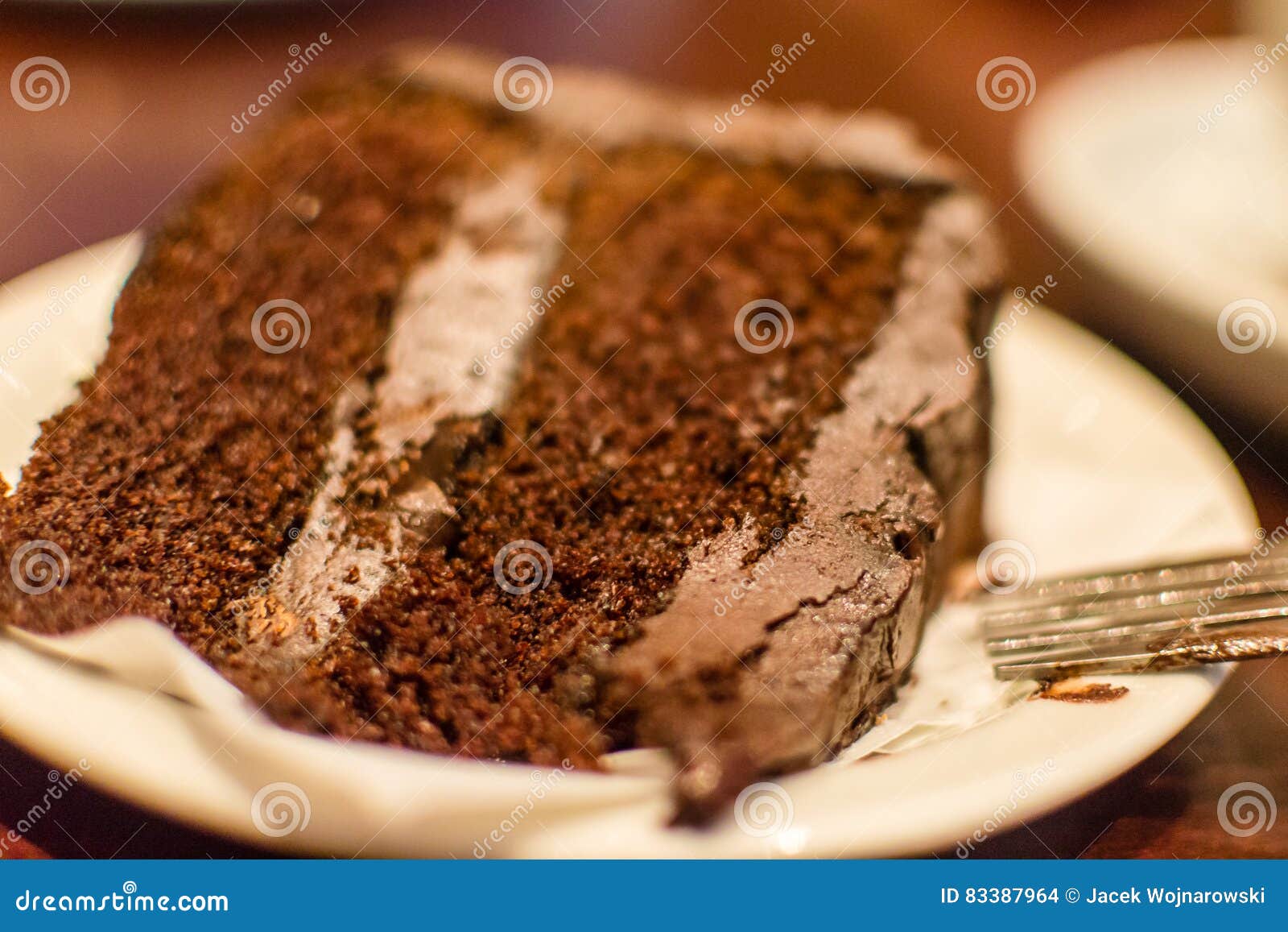 Slice of Chocolate Fudge Cake with Fork on a Plate C Stock Photo ...