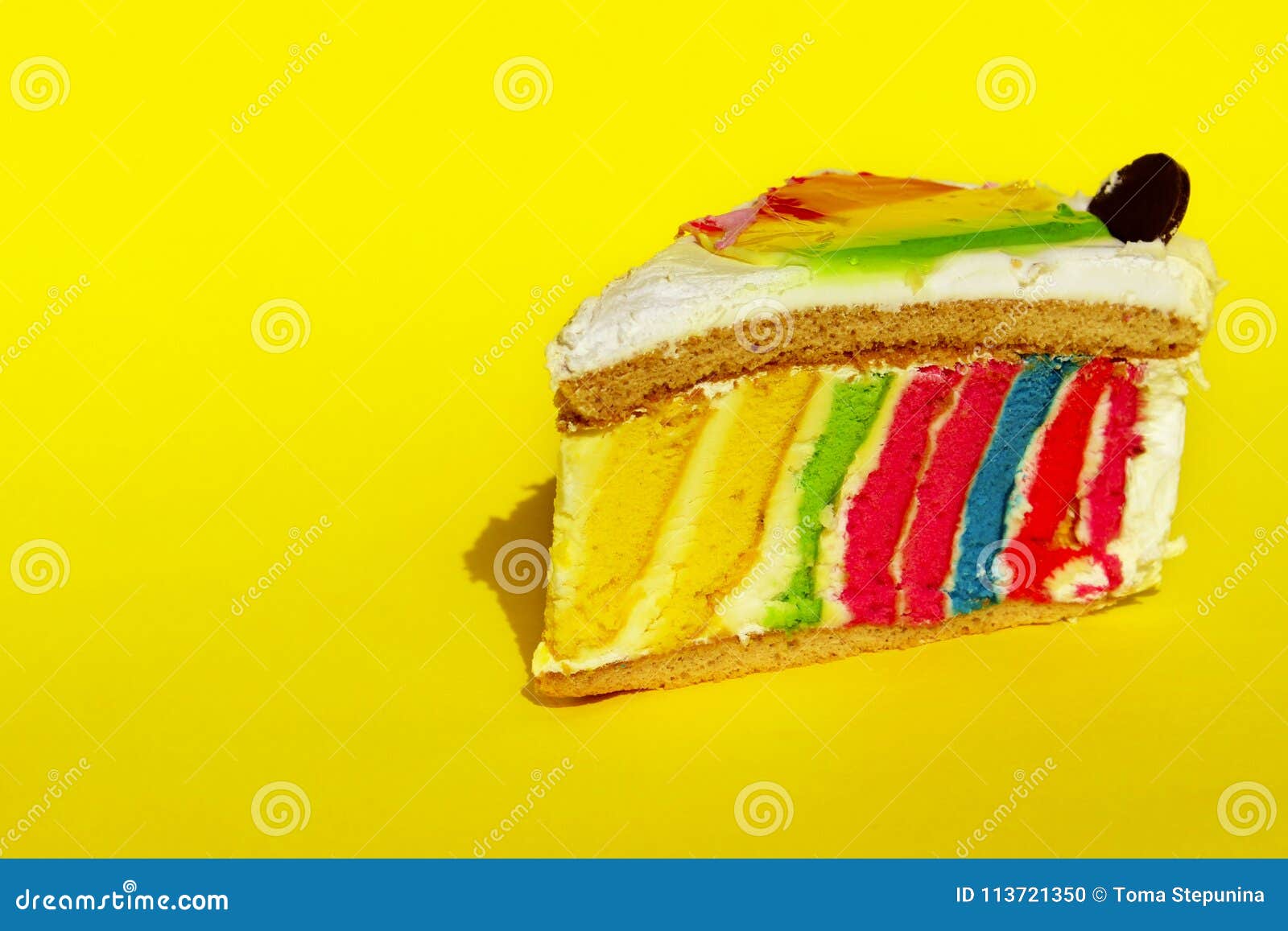 A Slice of Delicious Colored Cake on Yellow Background. Rainbow Cake ...