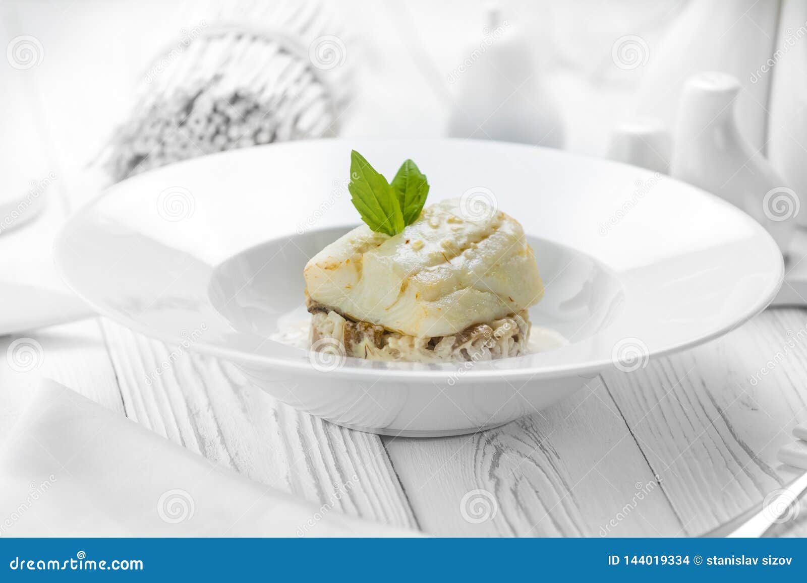 A Slice of Delicious Fish with Garnish and Sauce Stock Photo - Image of ...