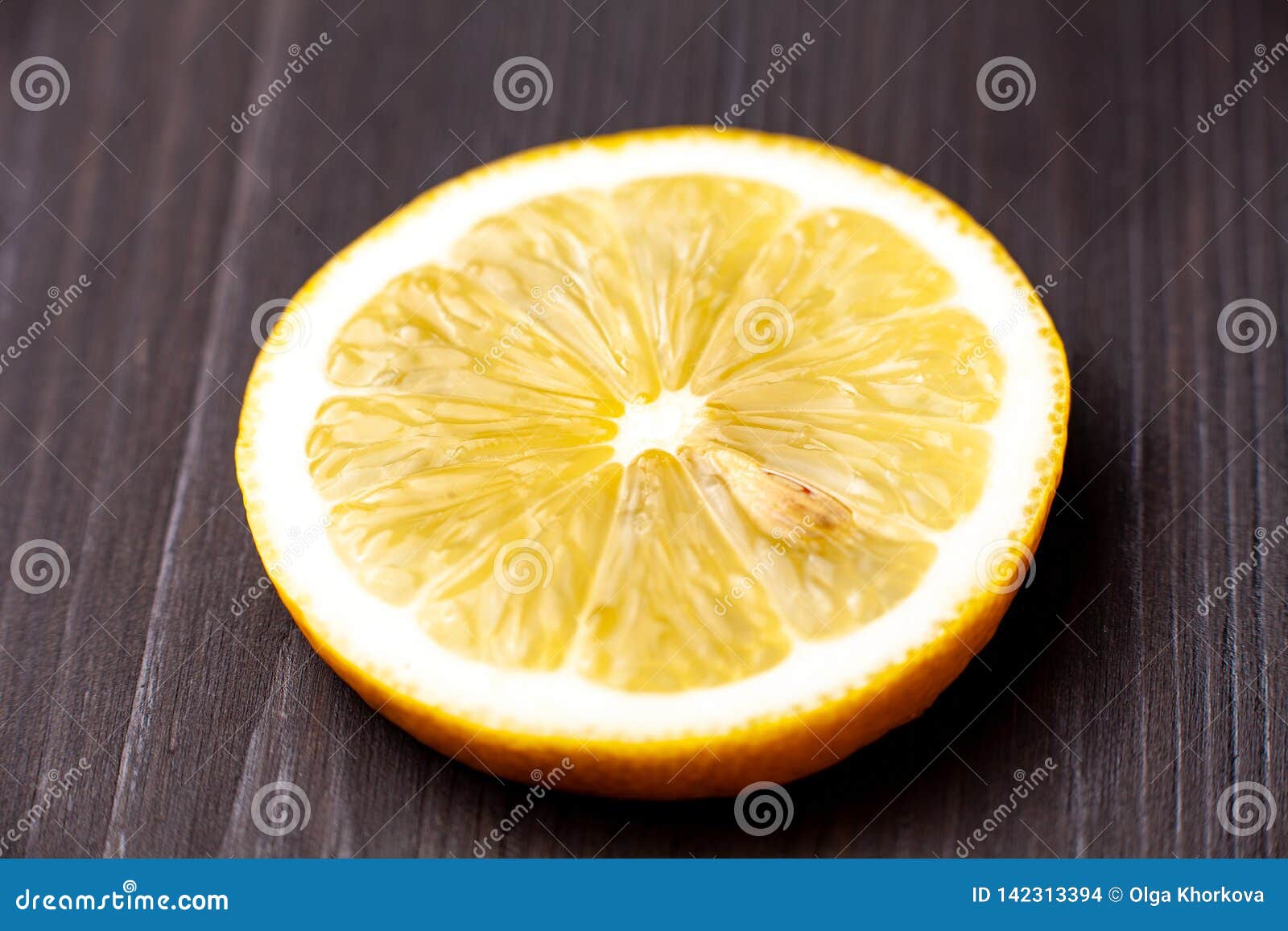 A slice of lemon close up stock photo. Image of cutting - 142313394