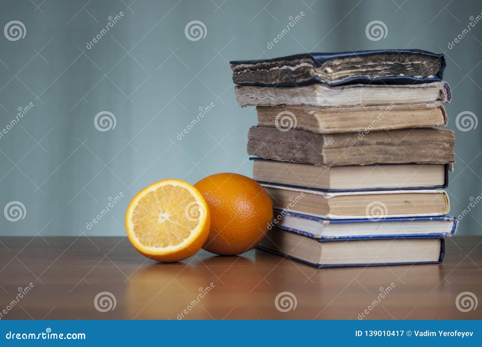 Slice Orange on a Pile of Old Books Stock Image - Image of nature, wood ...