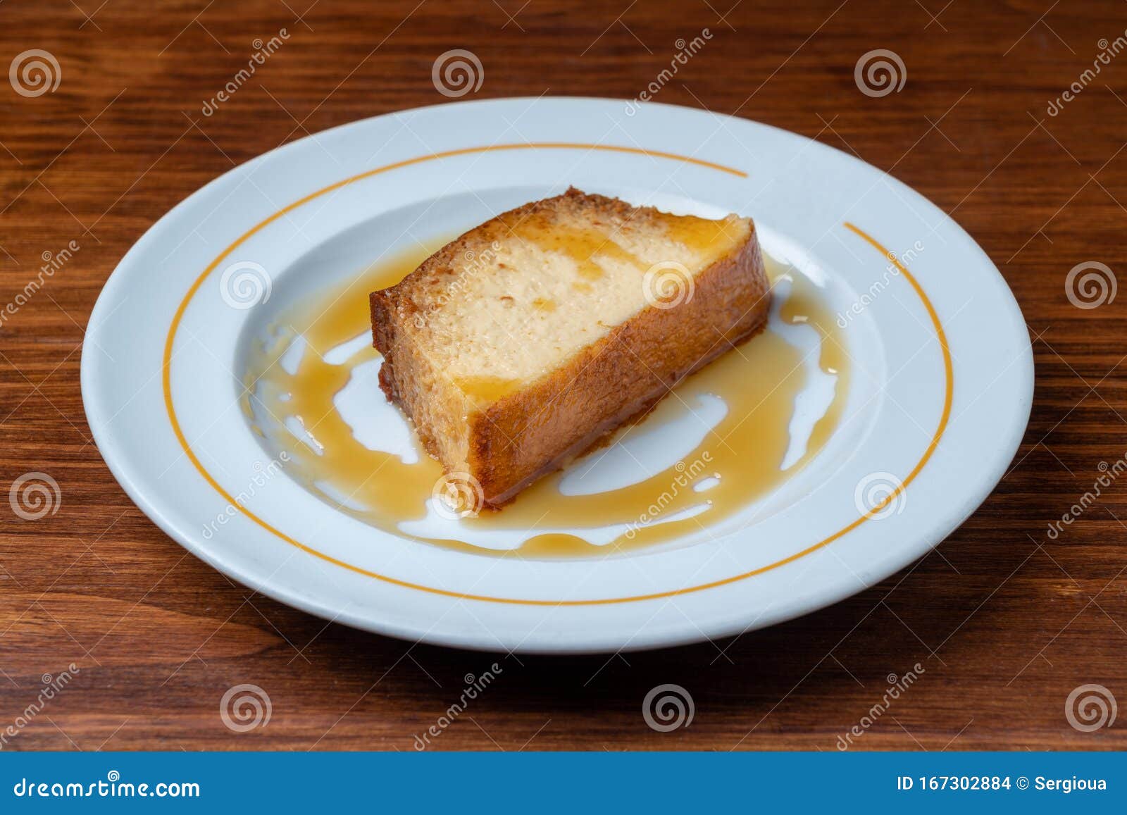 A Slice of Portuguese Dessert Caramel Pudding. on a Wooden Table. Stock ...