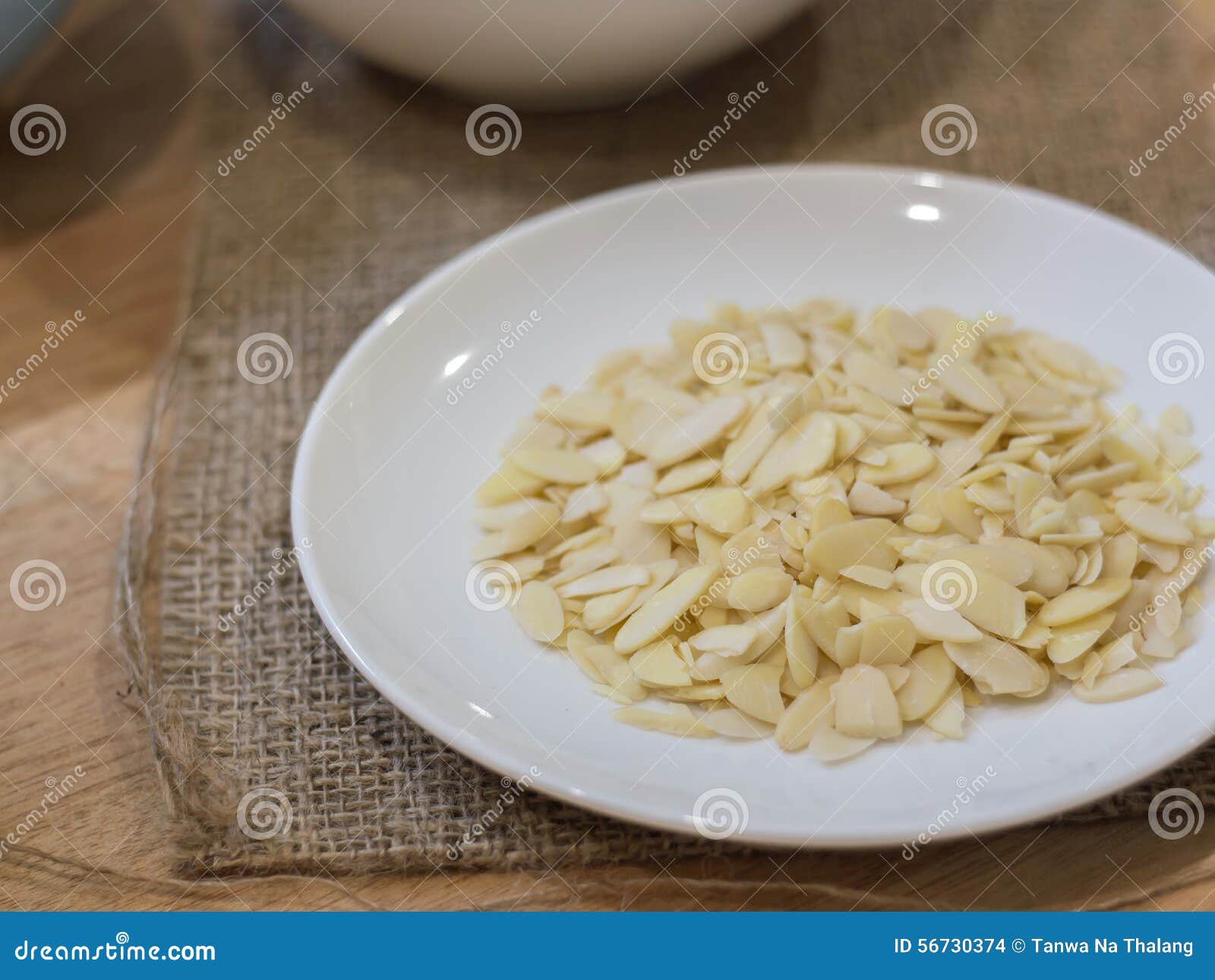 Sliced Almonds in White Plate Stock Photo - Image of almond, brown ...