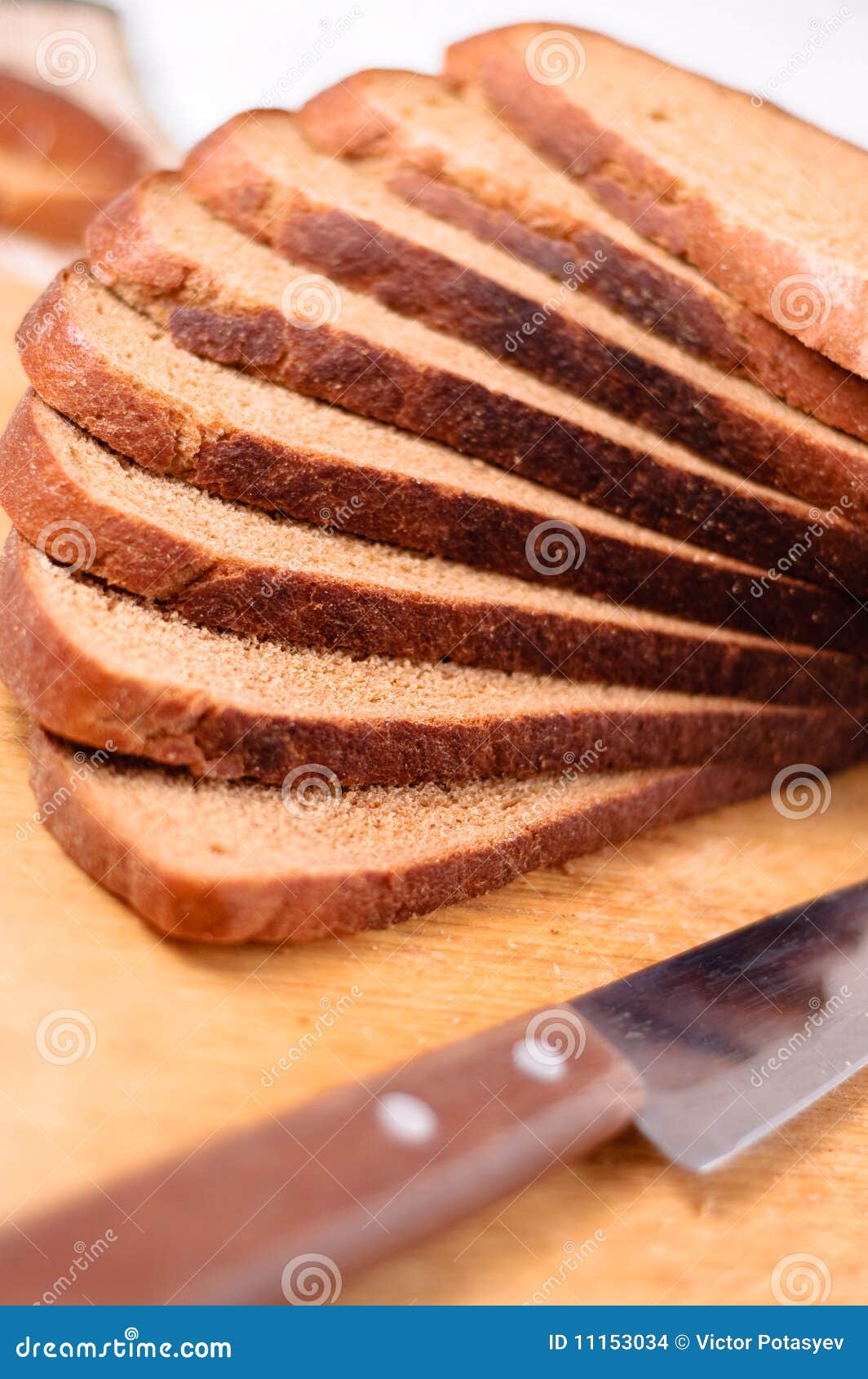Sliced Bread on a Wooden Cutting Board and Knife Stock Photo - Image of ...