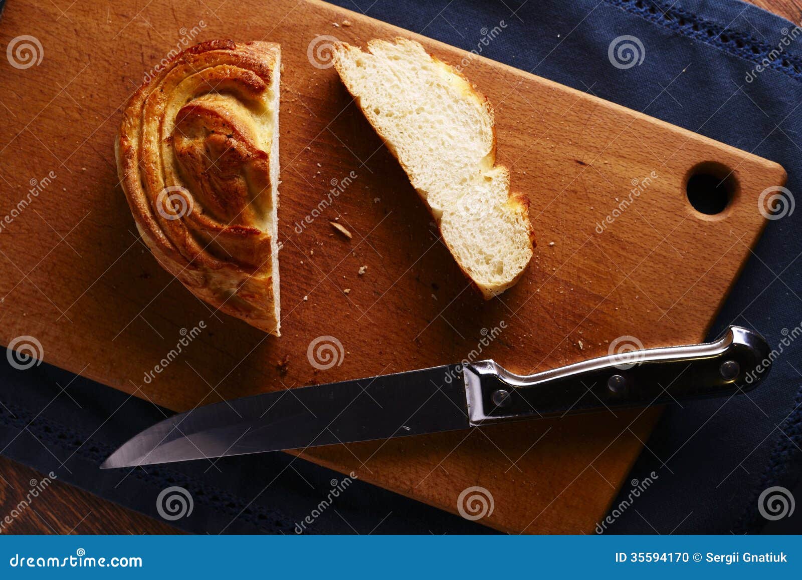 Sliced Bun on a Breadboard with a Knife Stock Photo - Image of ...