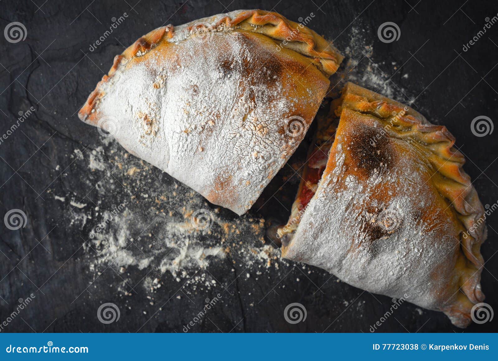 Sliced Calzone with Flour on the Dark Stone Background Top View Stock ...