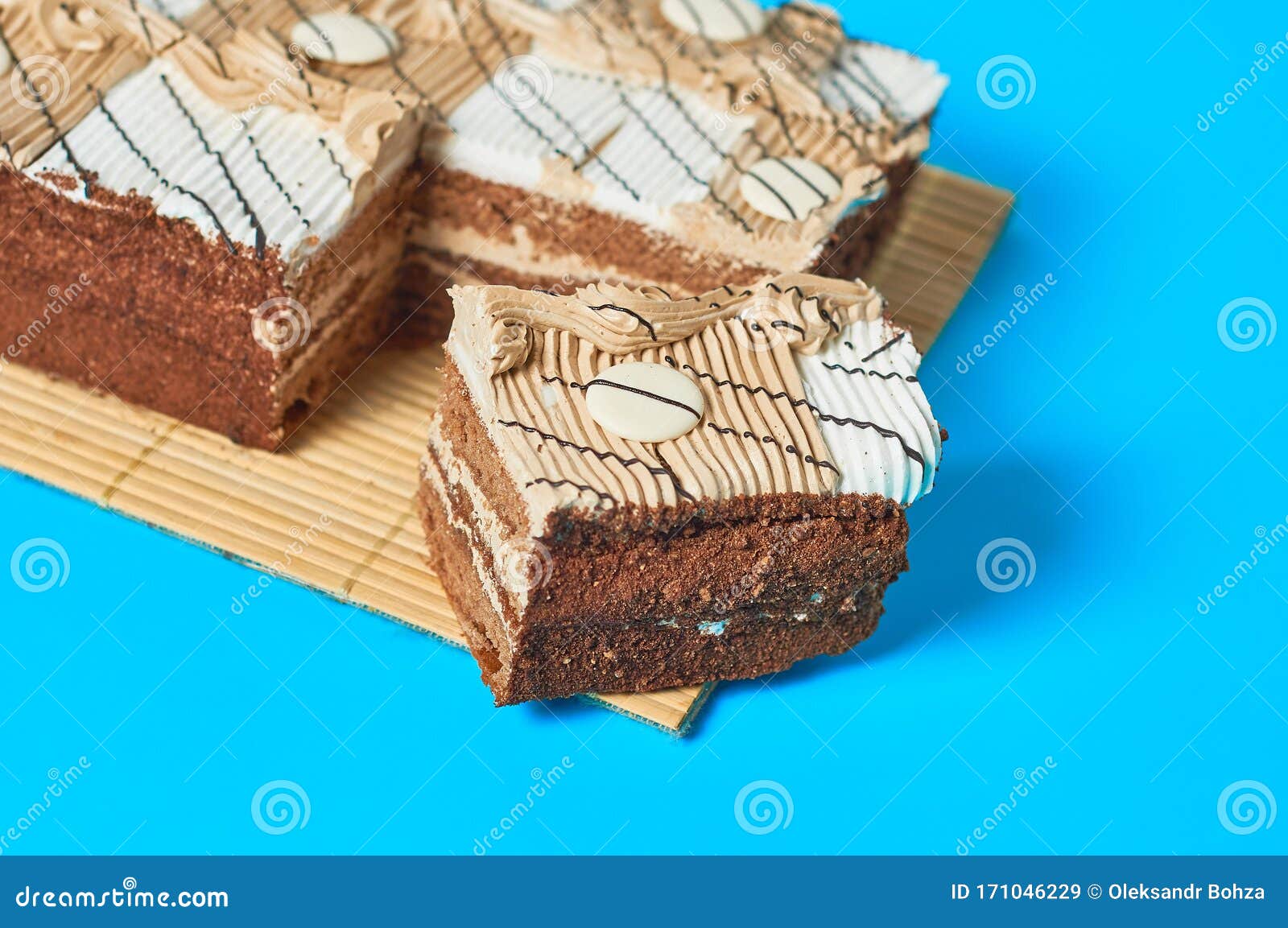 Sliced Checkered Rectangular Cake on Bamboo Mat Lies on Blue Table on ...