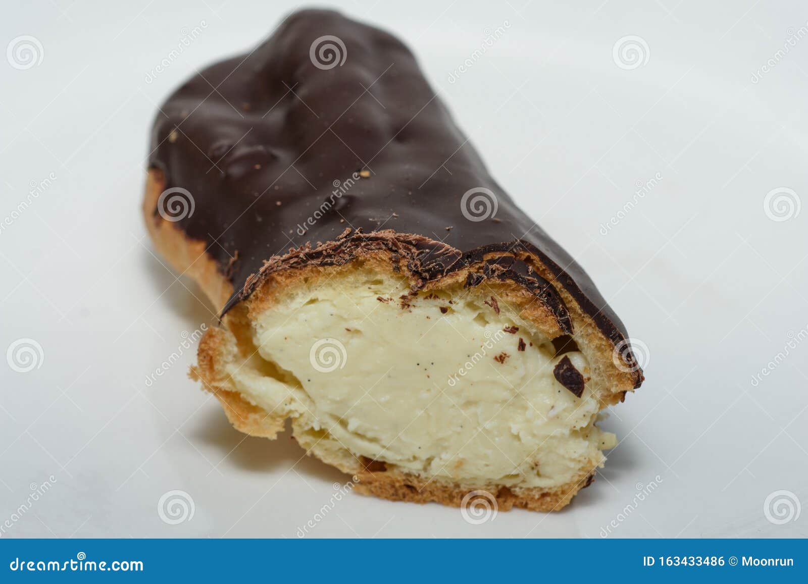 Sliced Chocolate Eclair on Plate Stock Photo - Image of white, fine ...