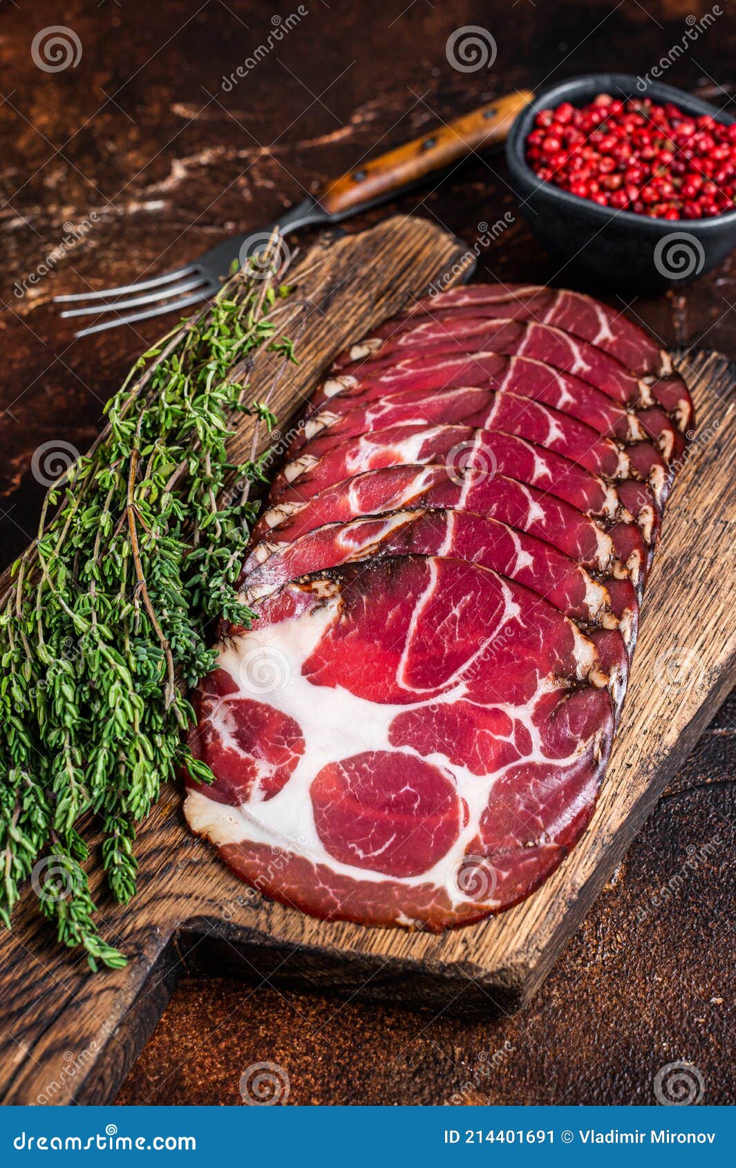 Sliced Cured Coppa Ham on Wooden Board with Thyme. Dark Background ...