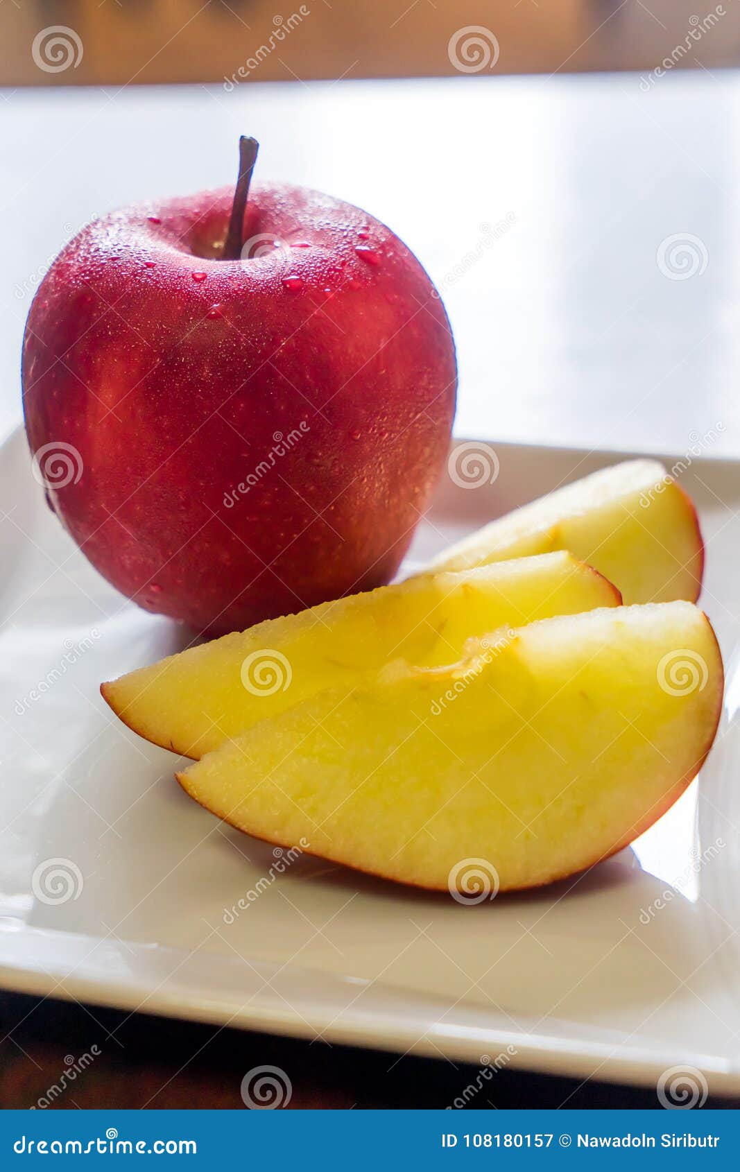 Sliced Fresh Red Apple on a White Square Dish Stock Image - Image of ...