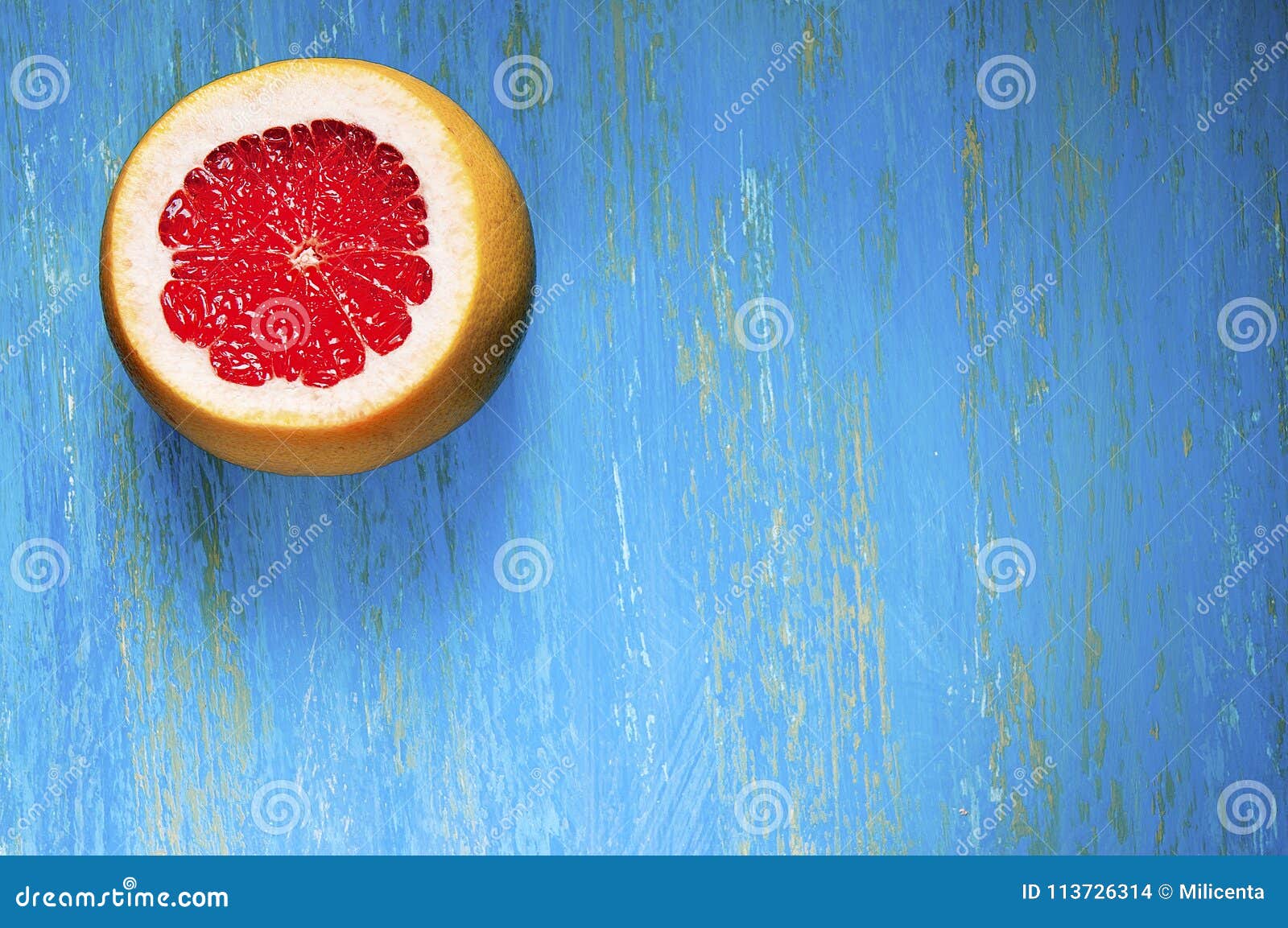 Sliced Grapefruit on a Blue Background Stock Photo - Image of ripe ...