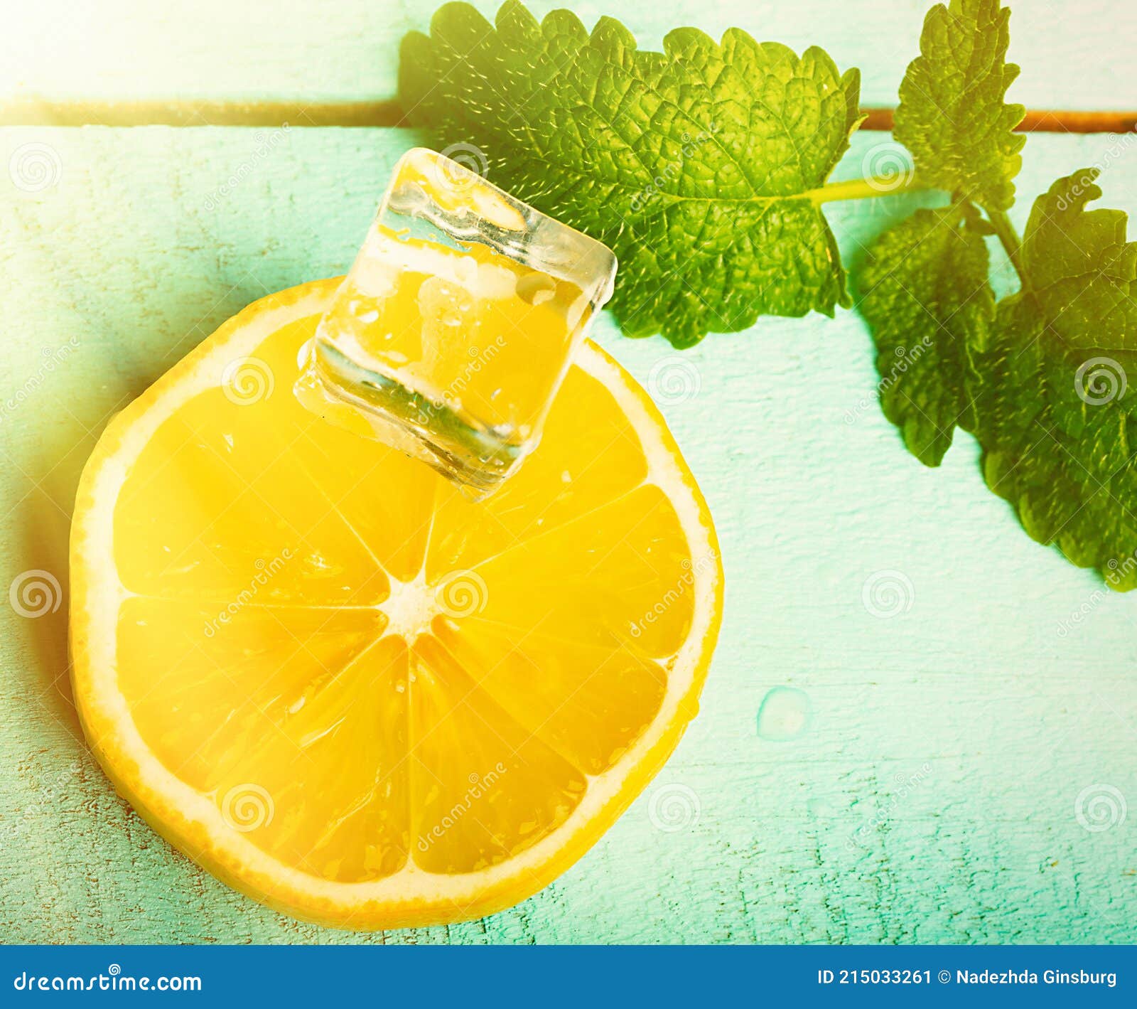 Sliced Lemon with Mint and Ice on the Turquoise Surface of the Table ...