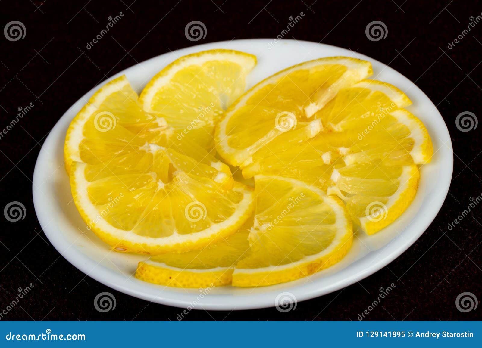 Sliced lemon in the plate stock image. Image of nature - 129141895