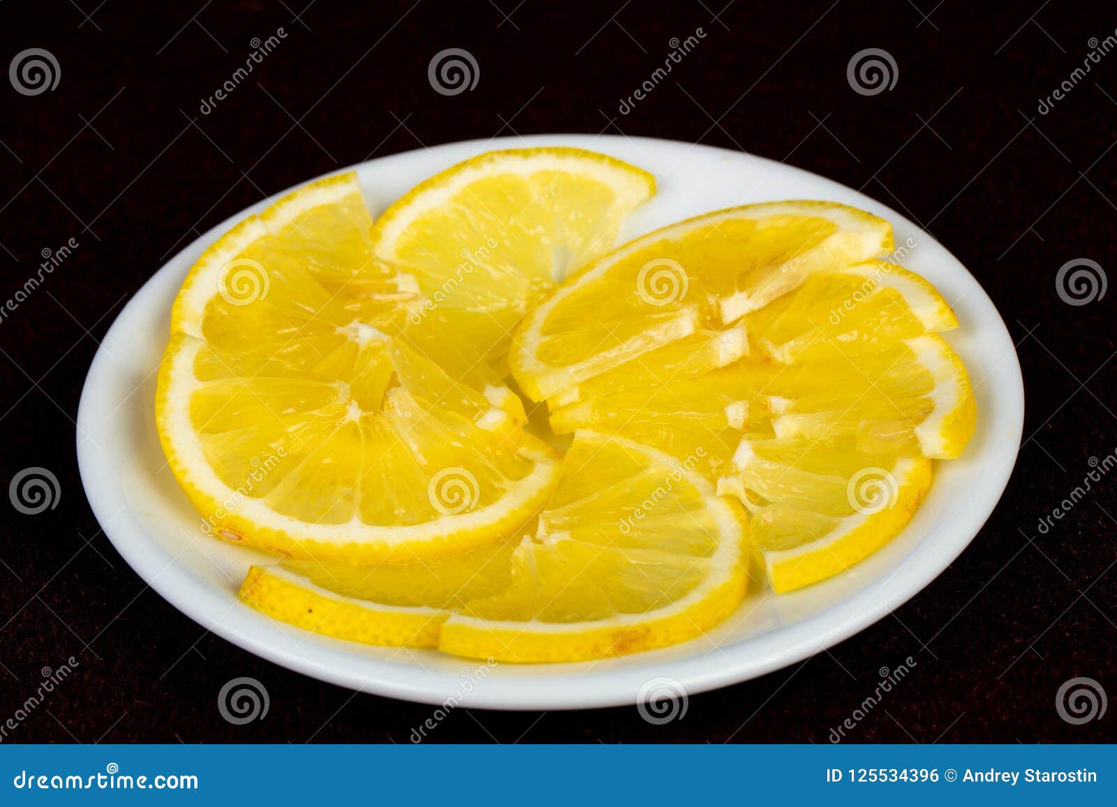 Sliced lemon in the plate stock photo. Image of background - 125534396