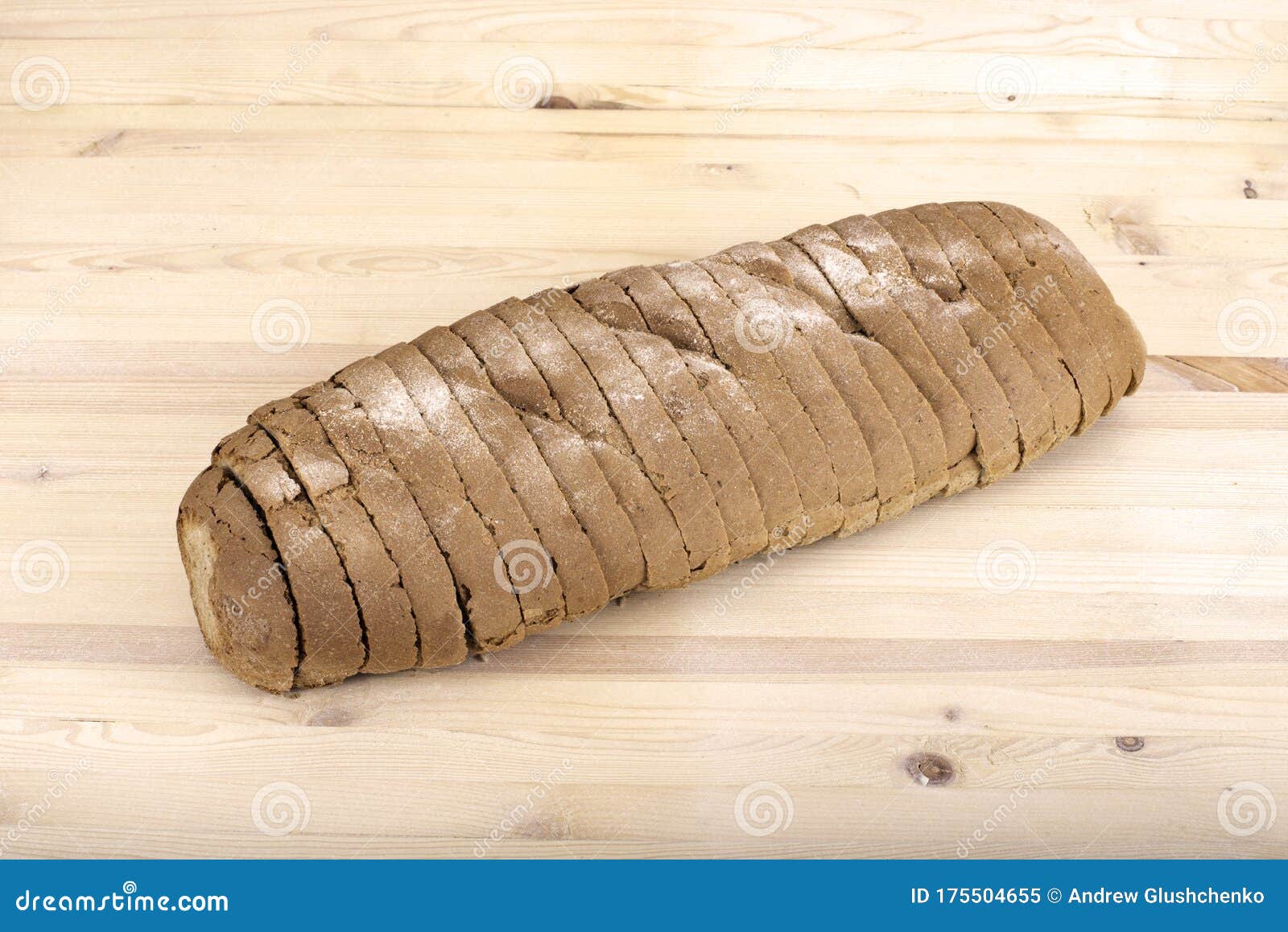 Sliced Loaf of Bread Lying on a Wooden Table Stock Image - Image of ...