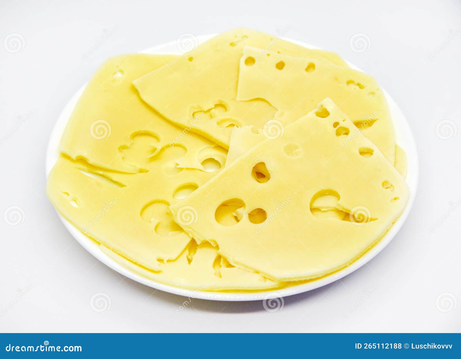 Sliced Pieces of Yellow Cheese with Holes on the Plate. Chopped Cheese ... Sliced Pieces of Yellow Cheese with Holes on the Plate. Chopped Cheese ...