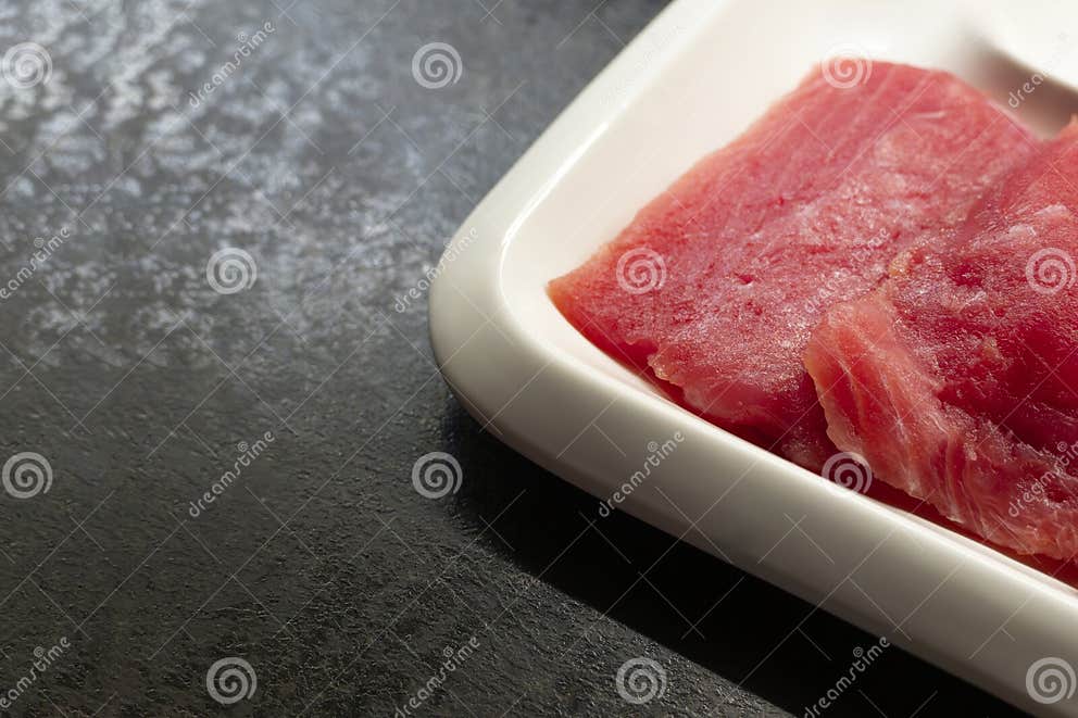 Sliced Raw Tuna Fish on White Rectangular Plate on Black Table Stock ...