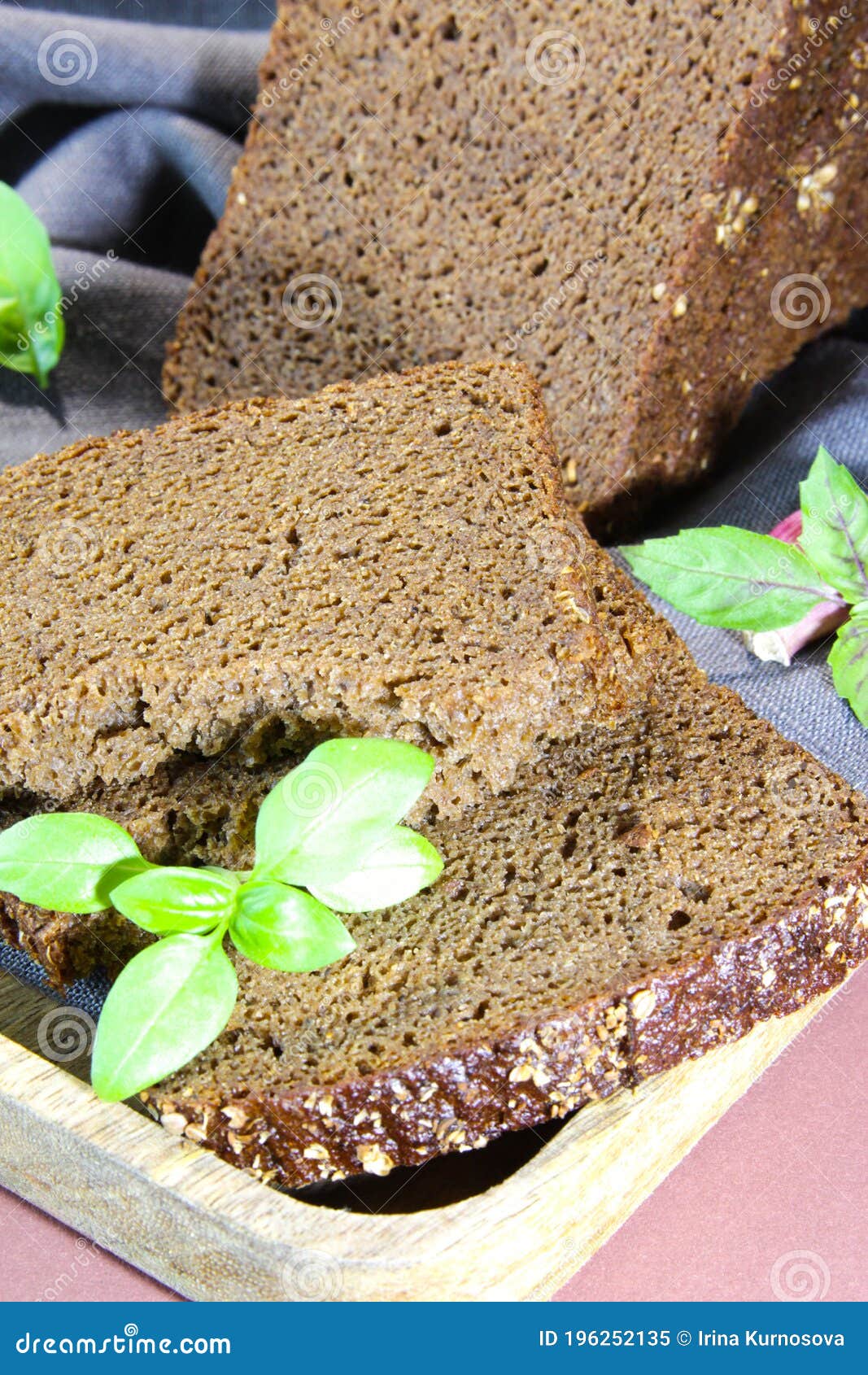 Sliced Rye Bread with Leaf Basil on Cutting Board. Whole Grain Rye ...