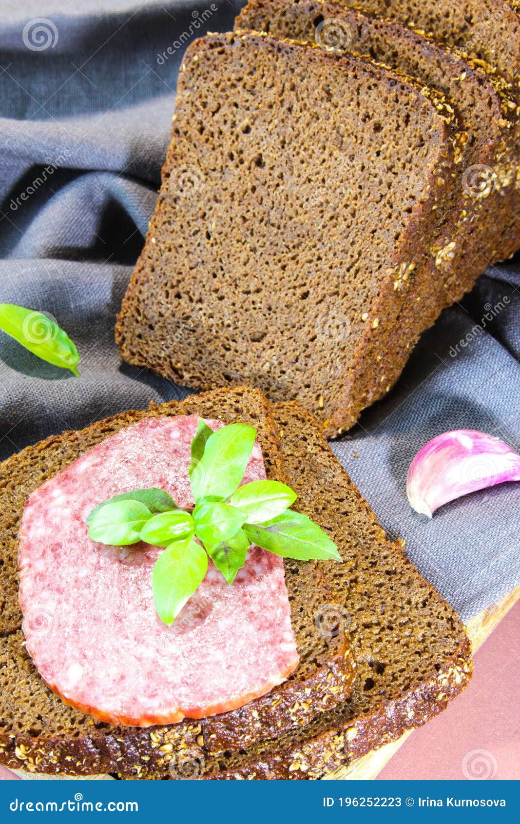 Sliced Rye Bread with Leaf Basil on Cutting Board. Whole Grain Rye ...
