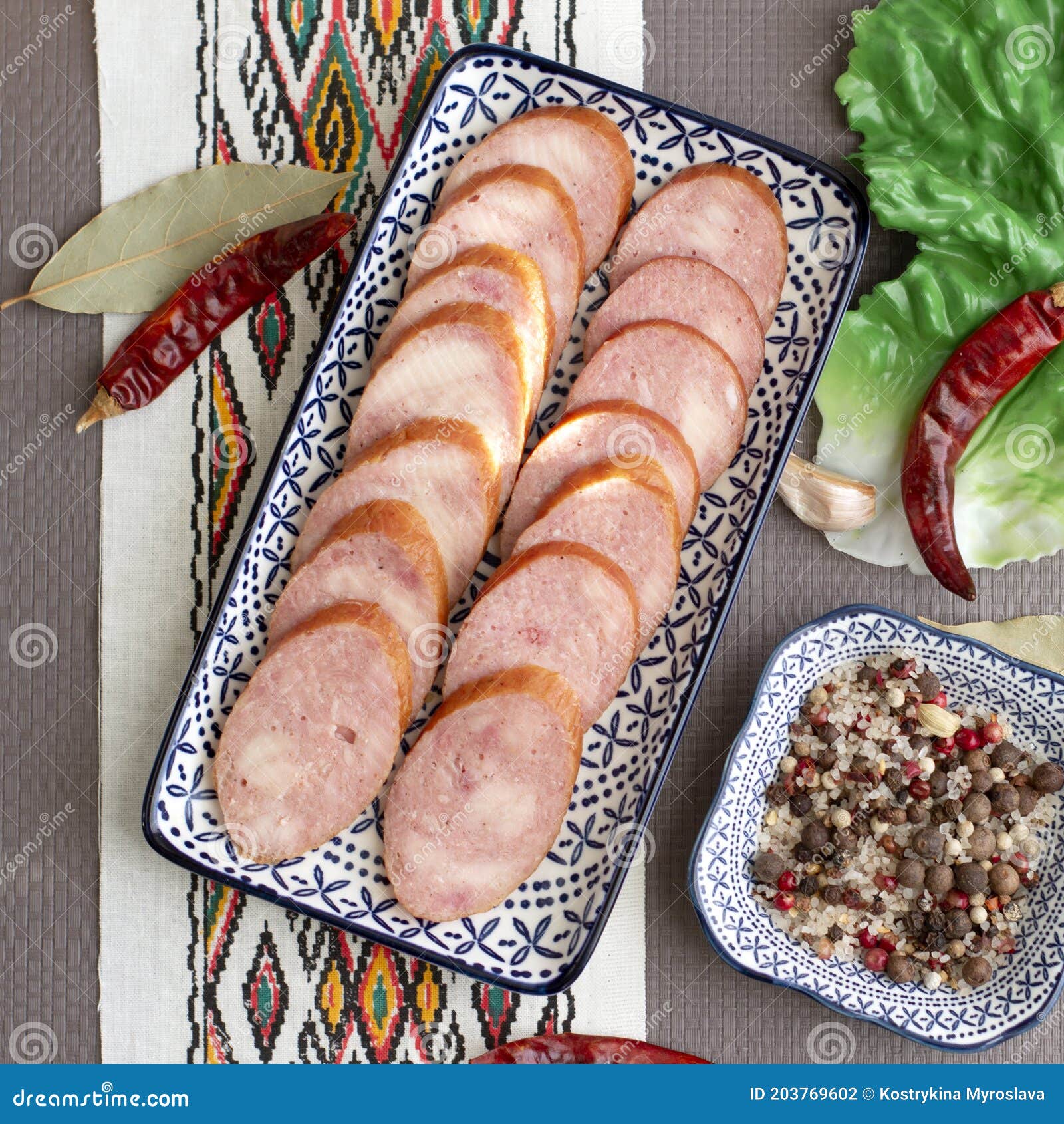 Sliced Sausage in a Rectangular Plate with a Blue Pattern with Garlic ...