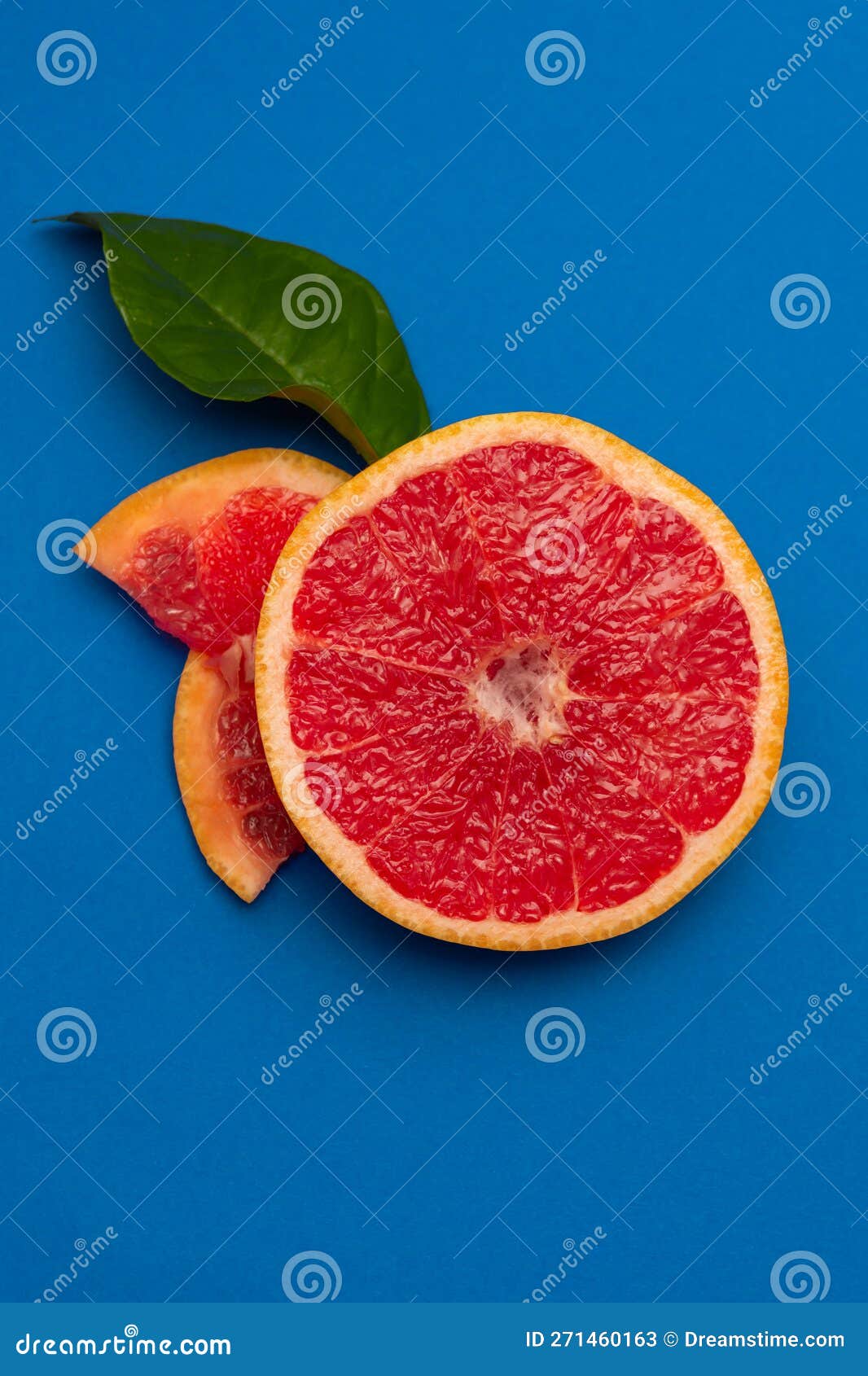 Sliced Sides of a Grapefruit, Three Pieces with a Green Leaf, Red Pulp ...