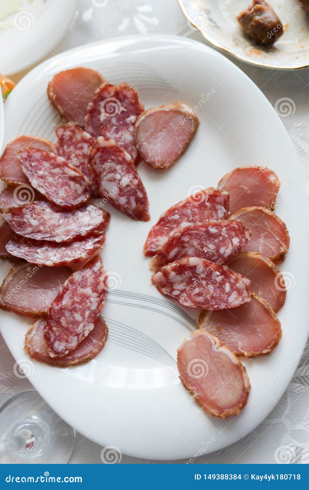 Sliced Smoked Sausage on a Plate. Smoked Sausage Sliced on a White ...