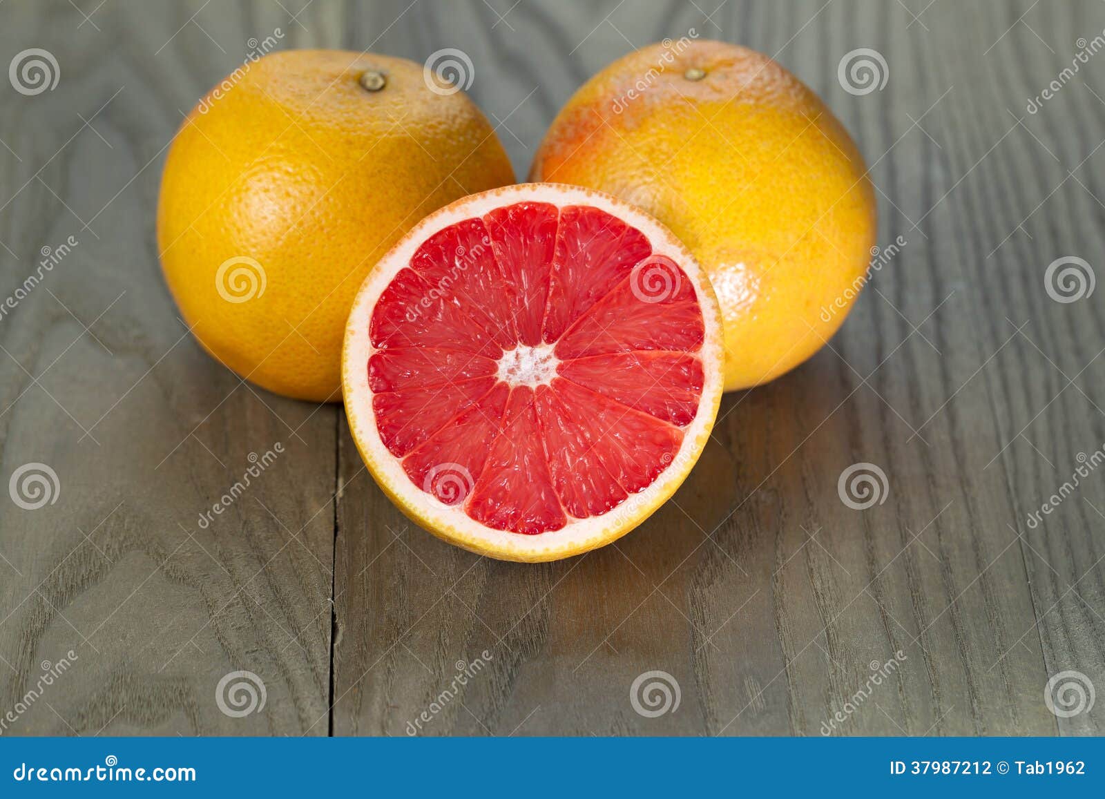 Sliced and Whole Ruby Red Grapefruits Stock Photo - Image of aged ...