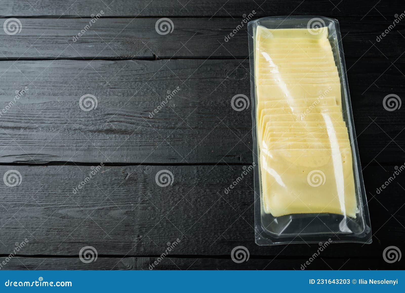 Slices of American Cheese in Plastic Pack, on Black Wooden Table with ...
