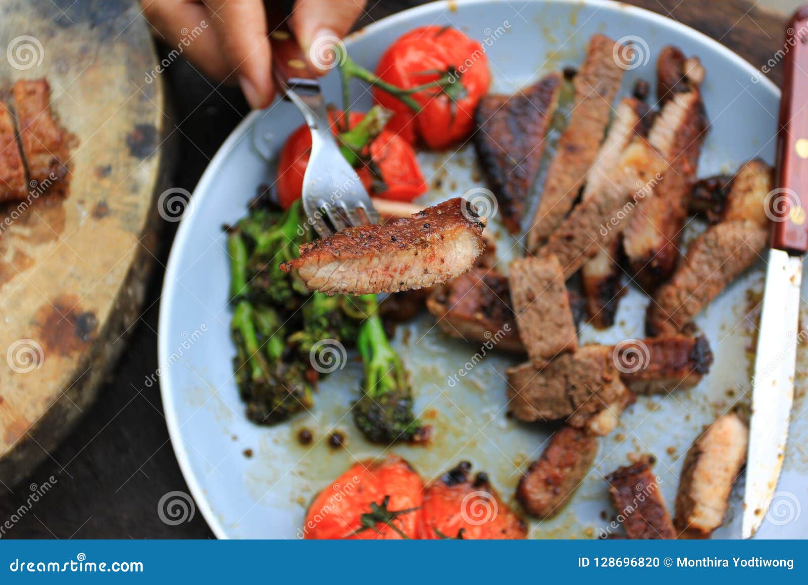 Slices of Beef Steak and Roast Vegetables on Meat Fork in the Bo Stock ... Slices of Beef Steak and Roast Vegetables on Meat Fork in the Bo Stock ...