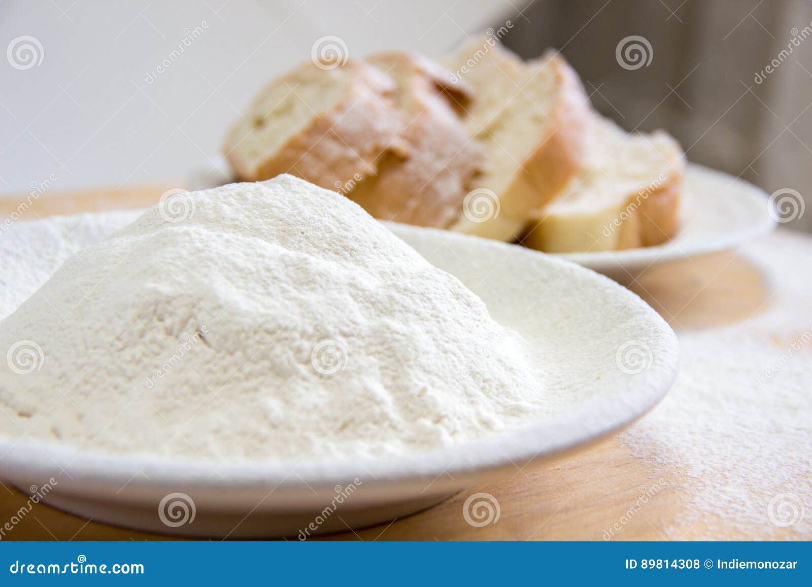 Slices of Bread and Wheat Flour in a White Plate on the Table Stock ...