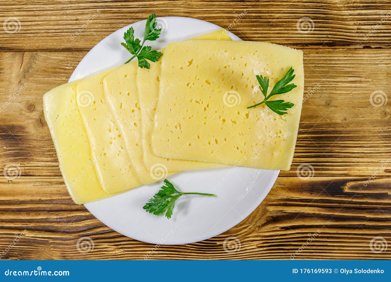 Slices of Cheese in a Plate on Wooden Table. Top View Stock Image ...