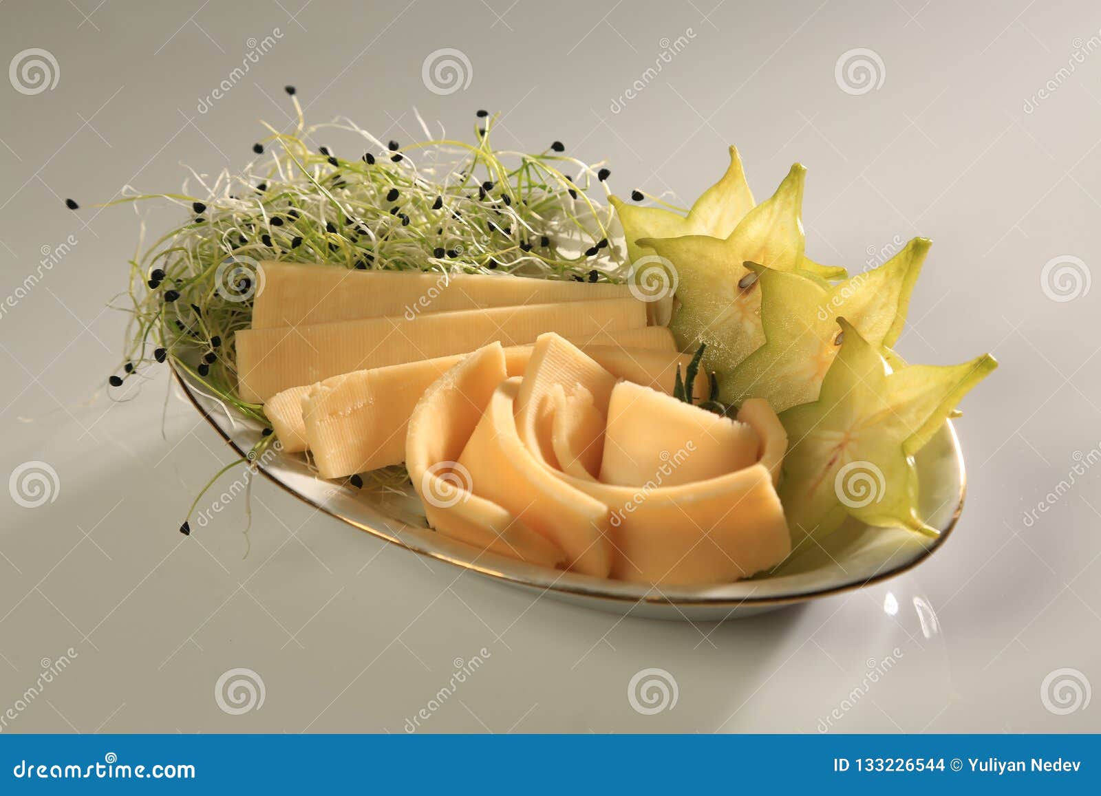 Slices of Chhese with Slices of Starfruit and Sprouts on the Side Stock ...