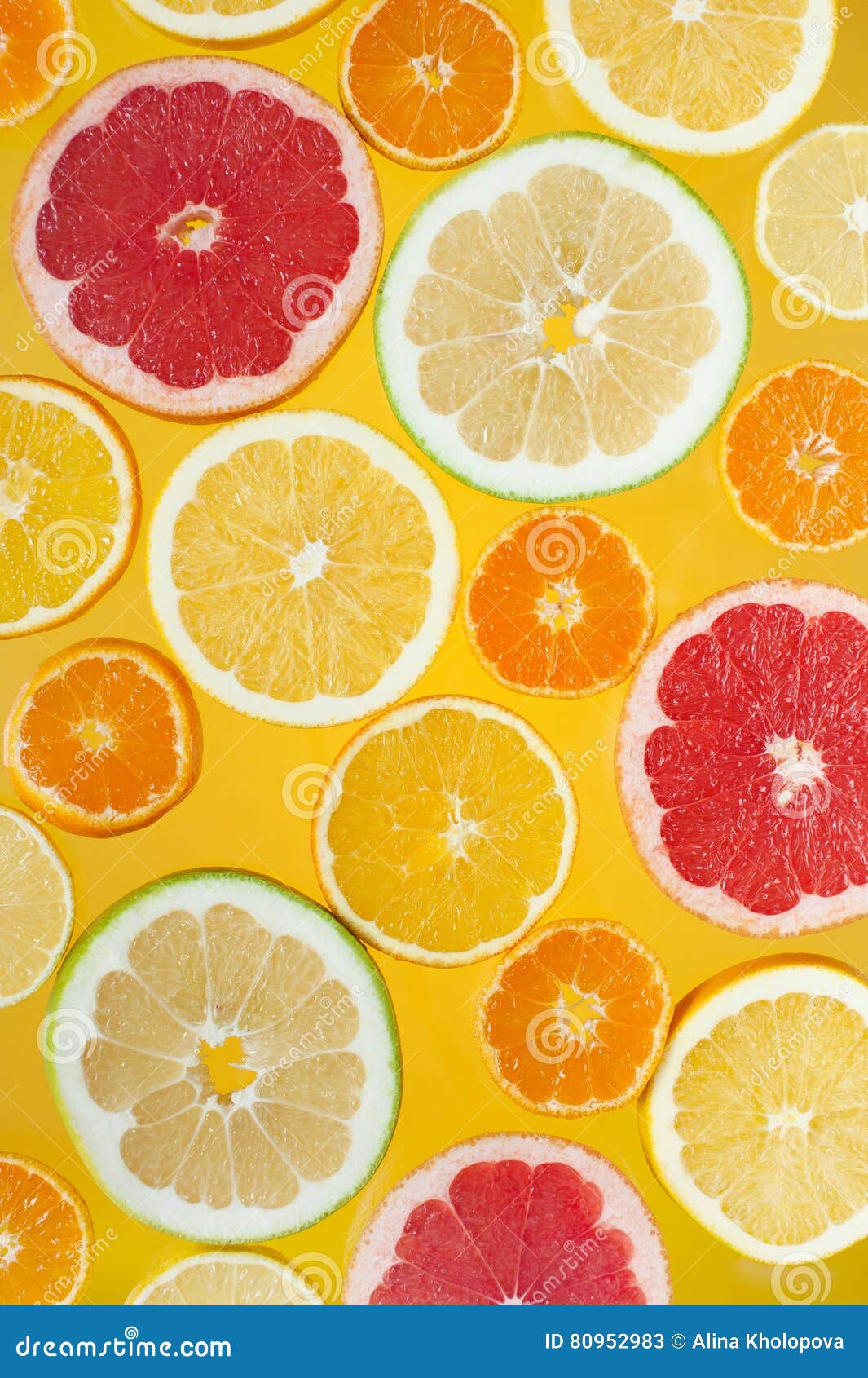 Slices of Citrus Fruits on the Bright Yellow Background Stock Image ...