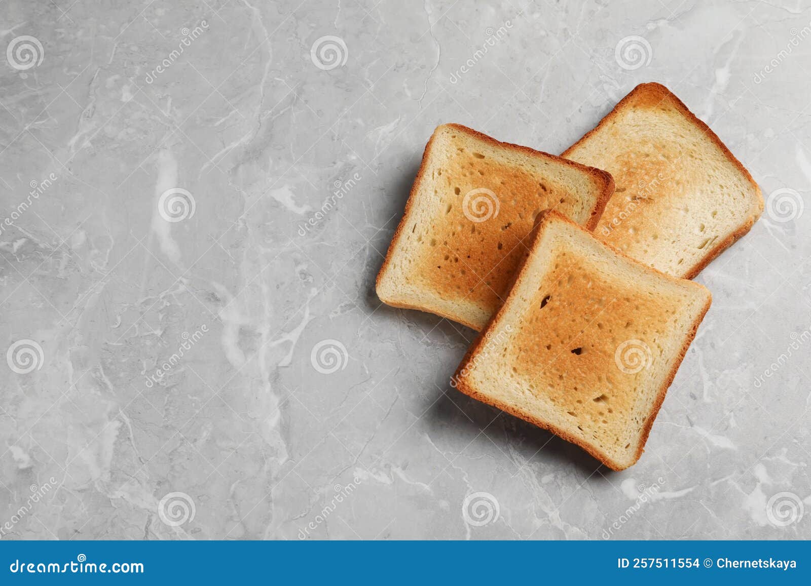 Slices of Delicious Toasted Bread on Gray Marble Table, Top View. Space ...