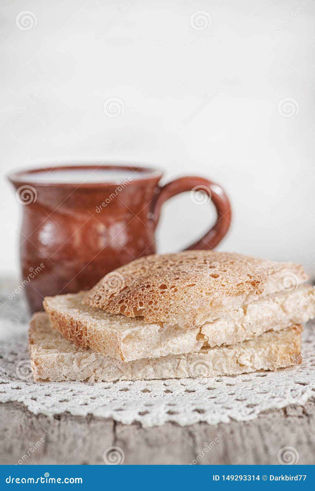 Slices of Fresh Bread and Cup of Milk on the Old Table Stock Photo ...