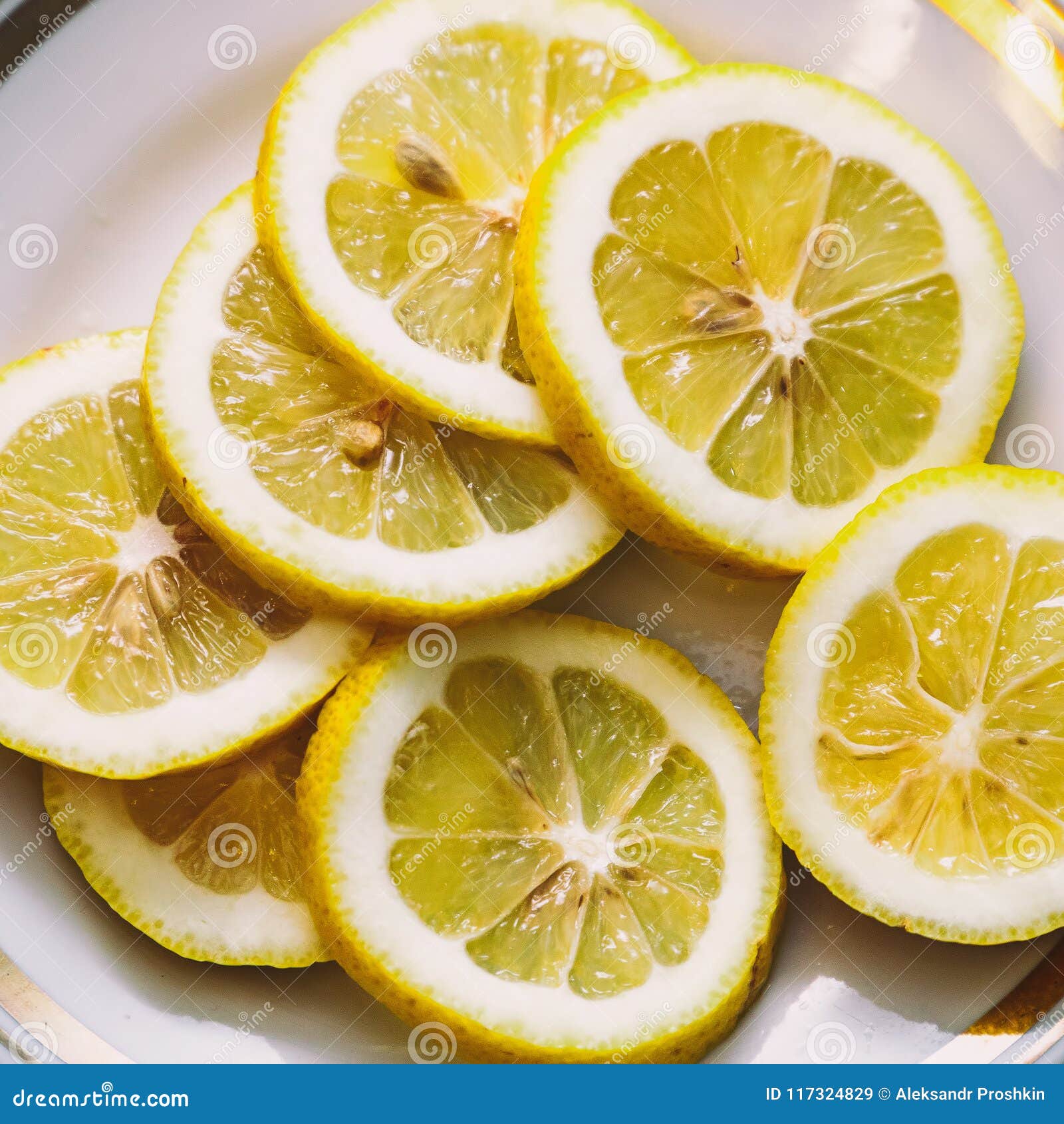 Slices of Lemon on White Plate Stock Image - Image of fresh, object ...