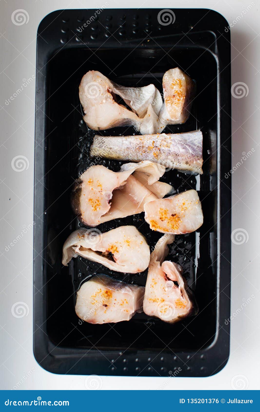 Slices of Pollock in Baking Dish. Plate of Cod or Pollack Fish Fillet ...