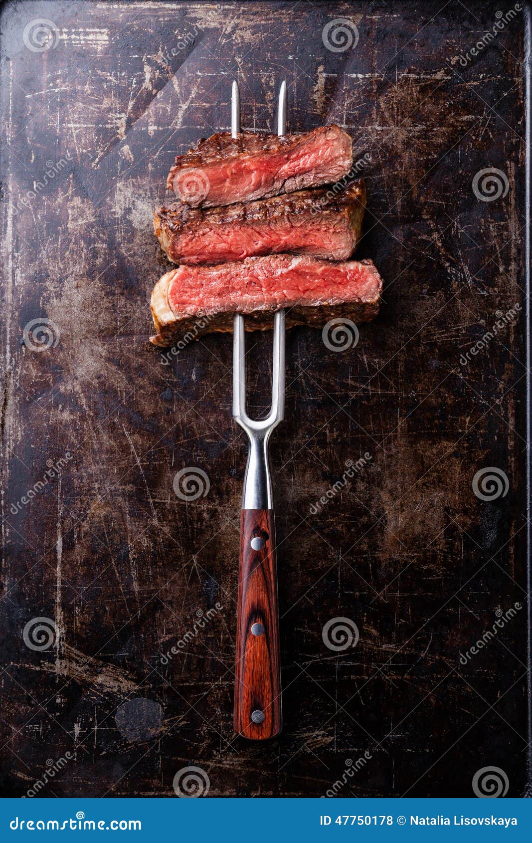 Slices of Rare Beef Steak on Meat Fork Stock Photo - Image of dark ...