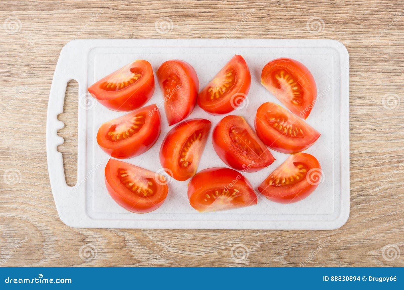 Slices of Red Tomatoes on Cutting Board on Wooden Table Stock Photo ...