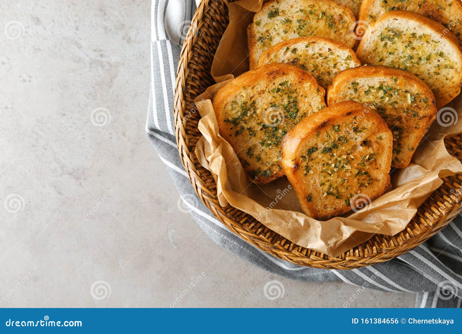 Slices of Toasted Bread with Garlic and Herbs on Grey Table Stock Photo ...