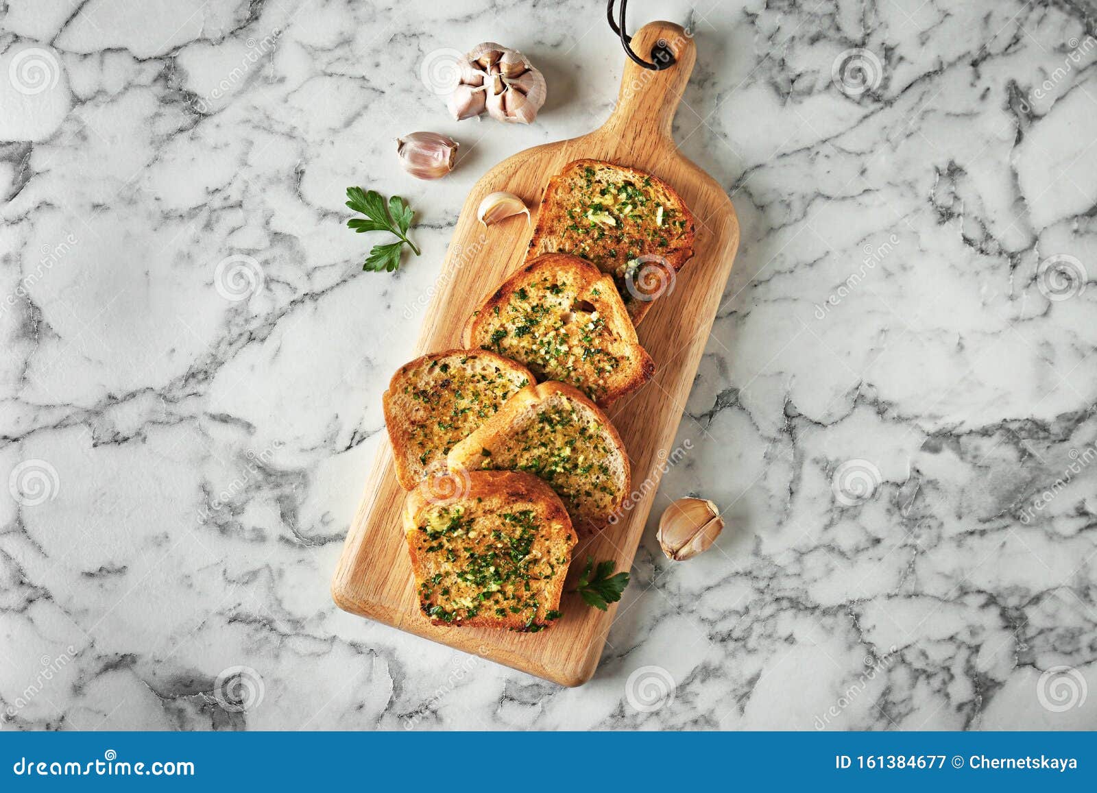 Slices of Toasted Bread with Garlic and Herbs on Table, Flat Lay Stock ...