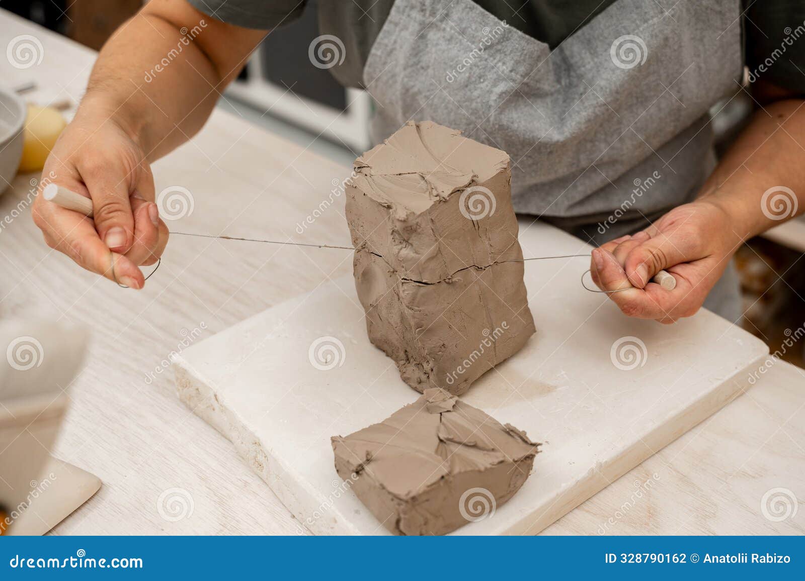 Slicing Off a Chunk of Clay from a Large Block Using a Sharp Wire Clay ...